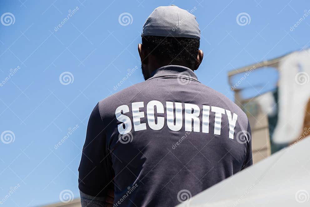 Security Person Standing Outdoors in the Sun, Shot from Back Stock ...