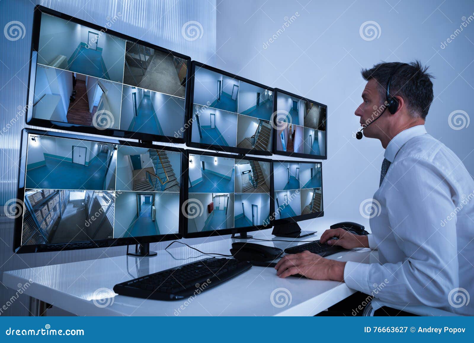 Security System Operator Looking at CCTV Footage at Desk Stock Image ...