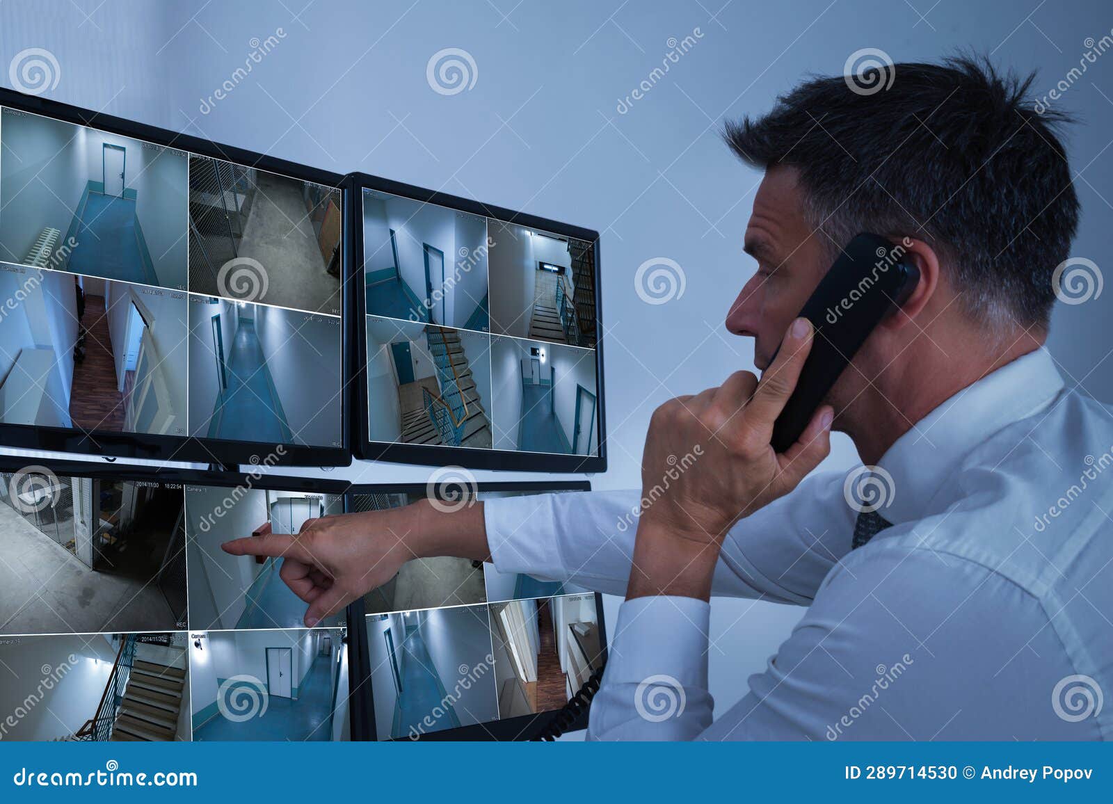 Security System Operator Looking at CCTV Footage Stock Photo - Image of ...