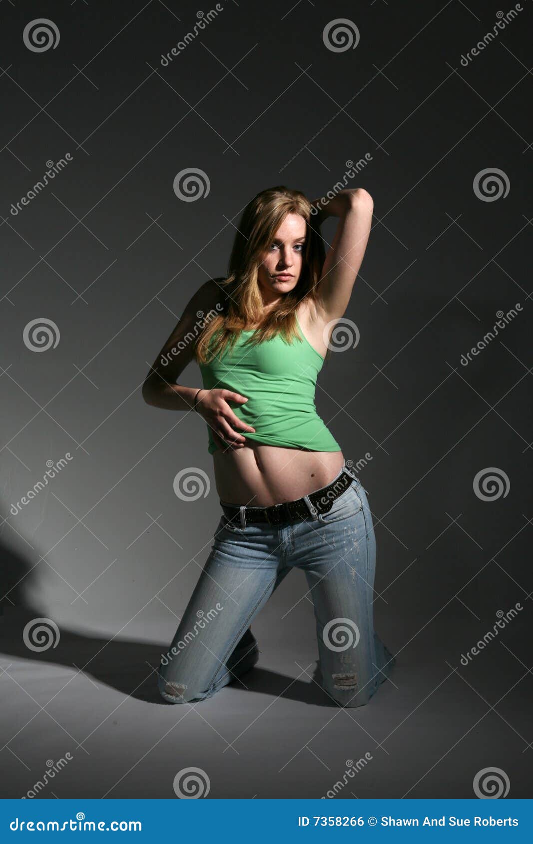 Seductive Young Woman Lifting Her Shirt Stock Photo - Image of denim ...