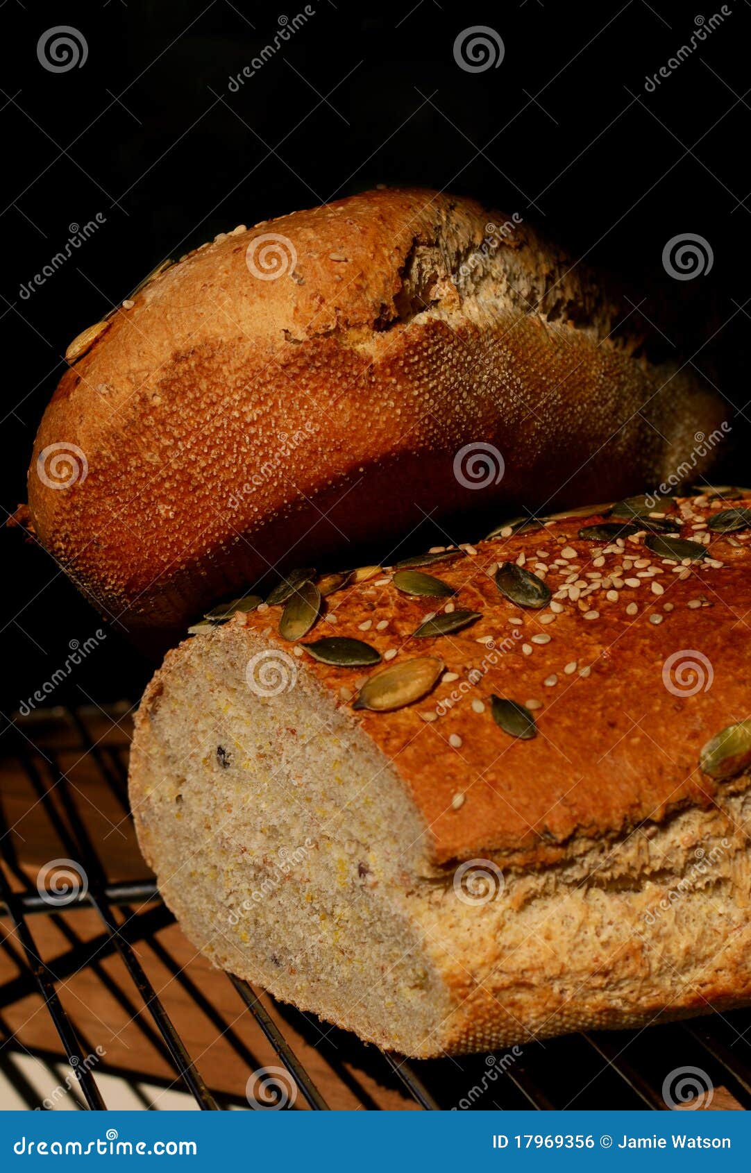 Seed loaf on wire rack stock photo. Image of knife, crust - 17969356