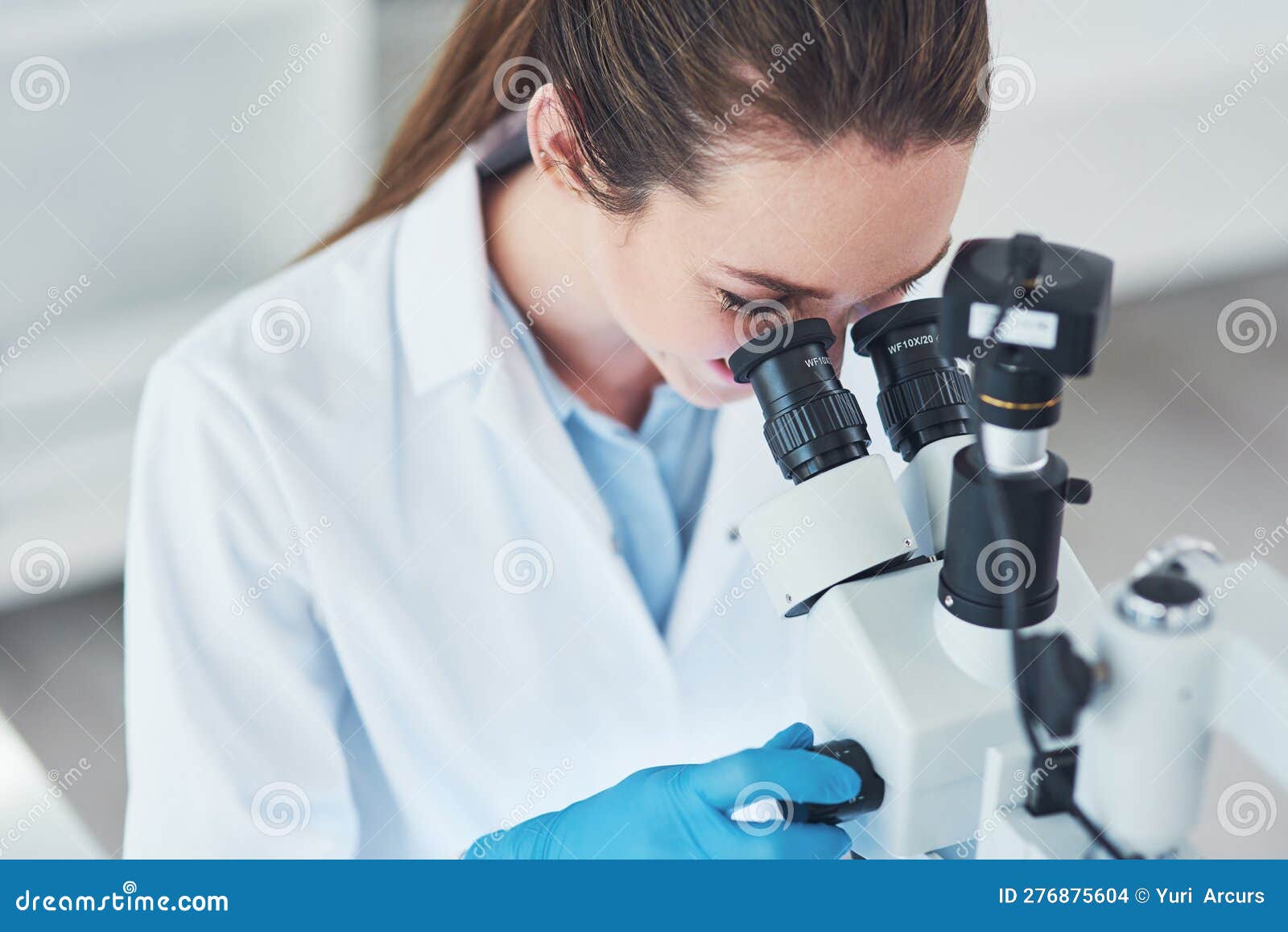 Seeing Life at a Small Scale. a Focused Young Female Scientist Looking ...