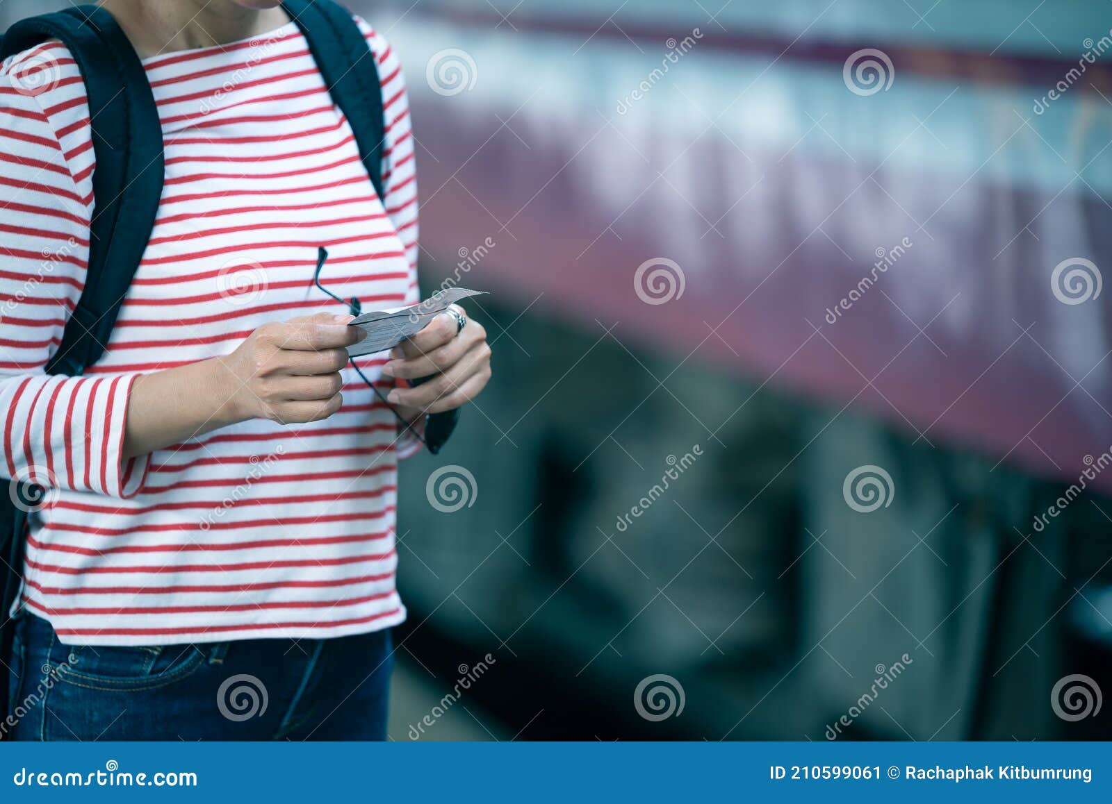 Selected Focus on Women Hands Holding a Train Ticker while Standing on ...