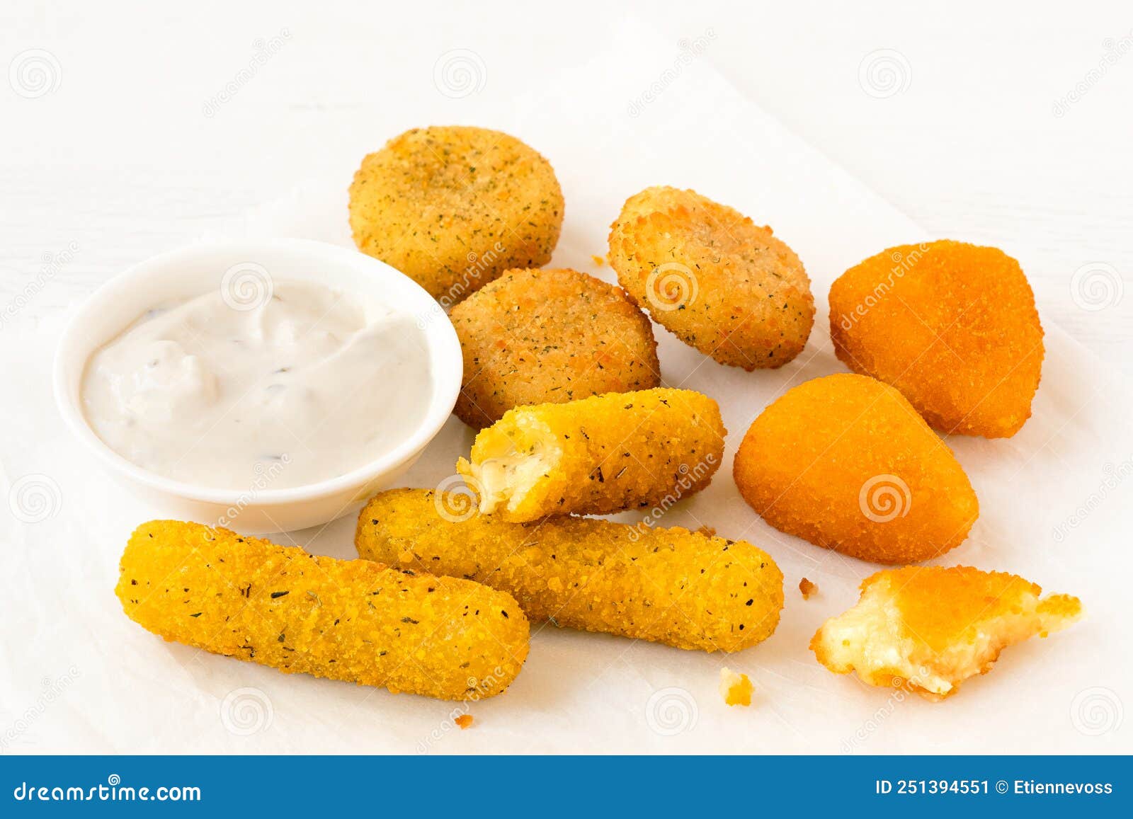 Selection of Breaded Fried Cheese on a White Baking Paper with White ...