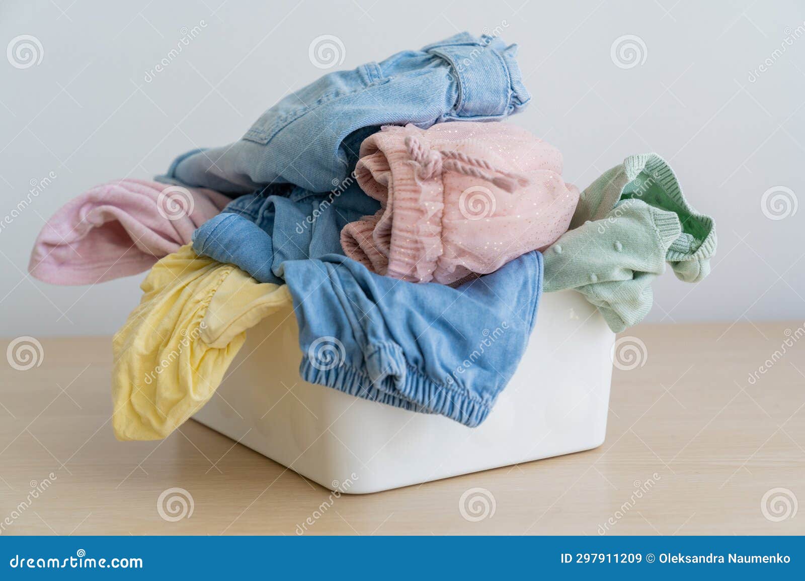 Selection of Fresh Unfolded Laundry in White Basket on Wood Table Stock ...