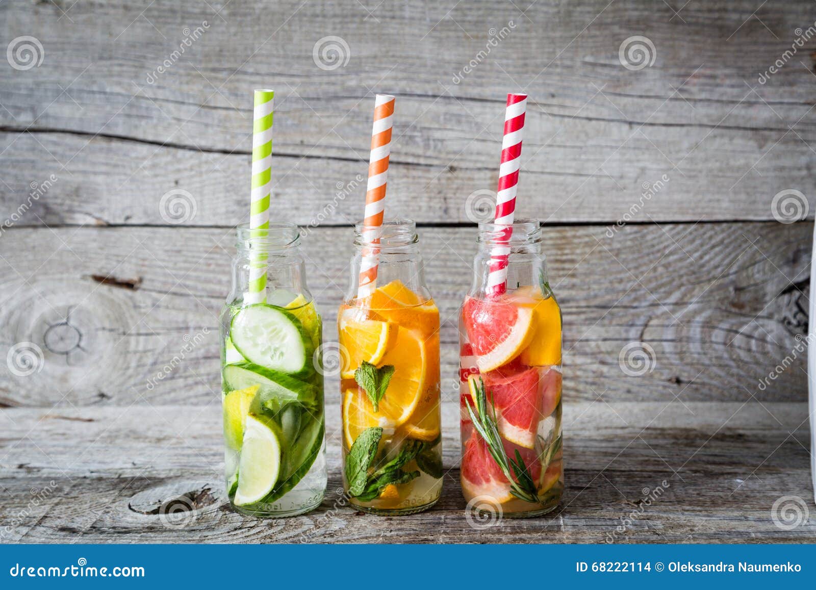 Selection of Infused Water in Glass Bottles, Rustic Wood Background ...