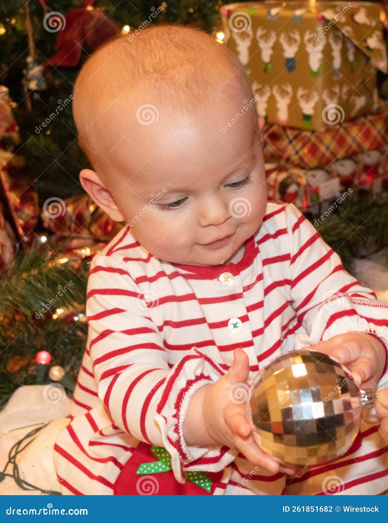 Selective of a Cute Baby Playing with a Christmas Tree Ball Stock Photo ...