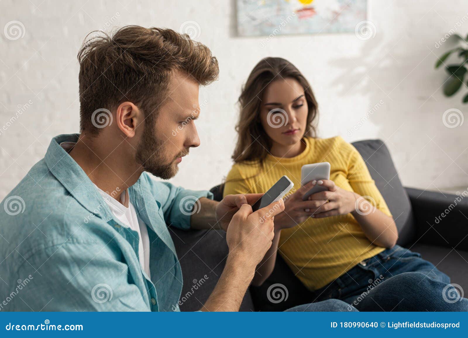 Focus of Addicted Couple Using Smartphones on Couch Stock Photo - Image ...