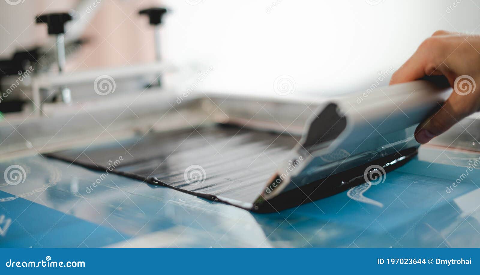 Artisan Holding Squeegee with Plastisol Ink while Working with Screen ...