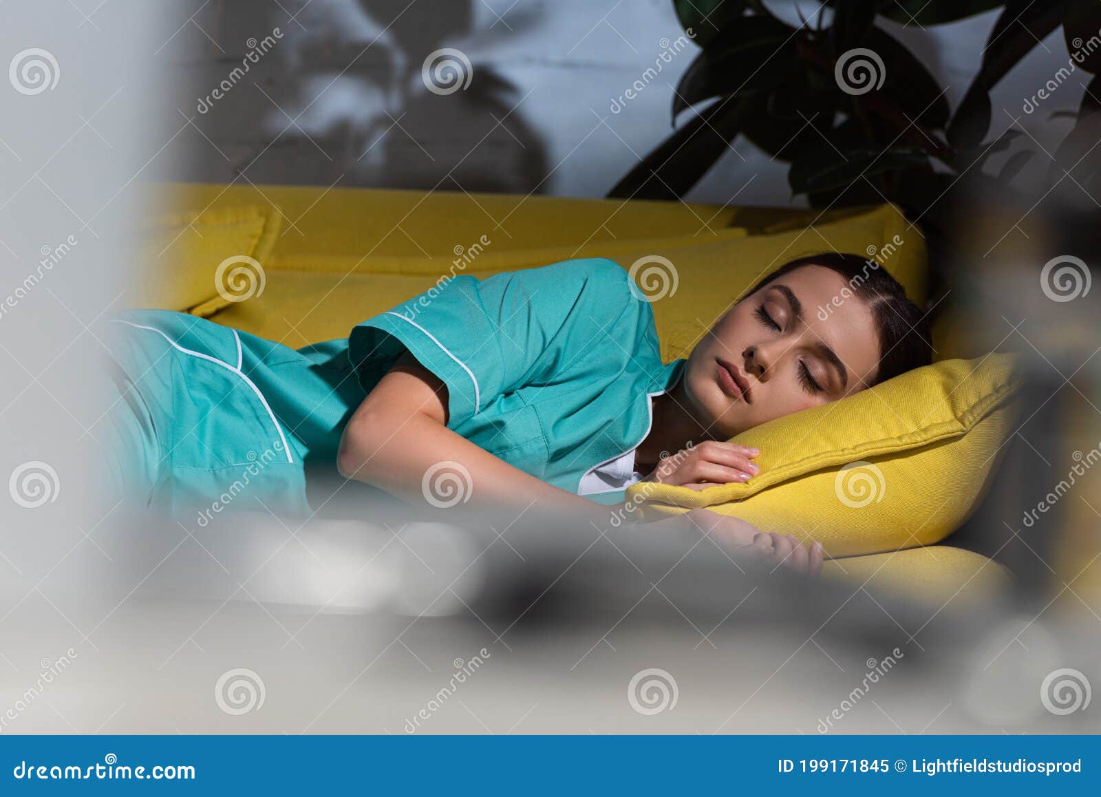 Focus of Attractive Nurse in Uniform Sleeping on Yellow Sofa during ...