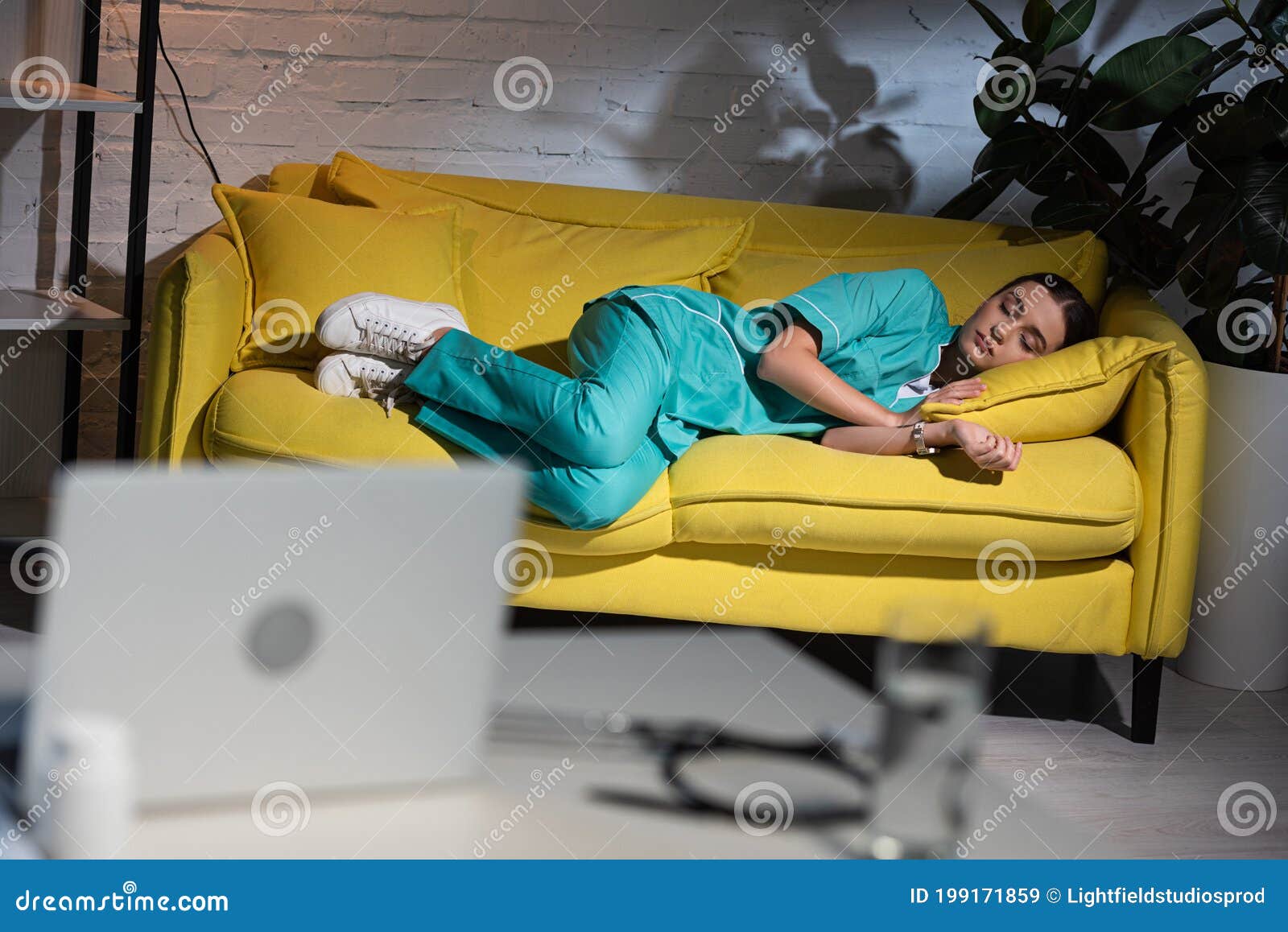 Focus of Attractive Nurse in Uniform Sleeping on Yellow Sofa during ...