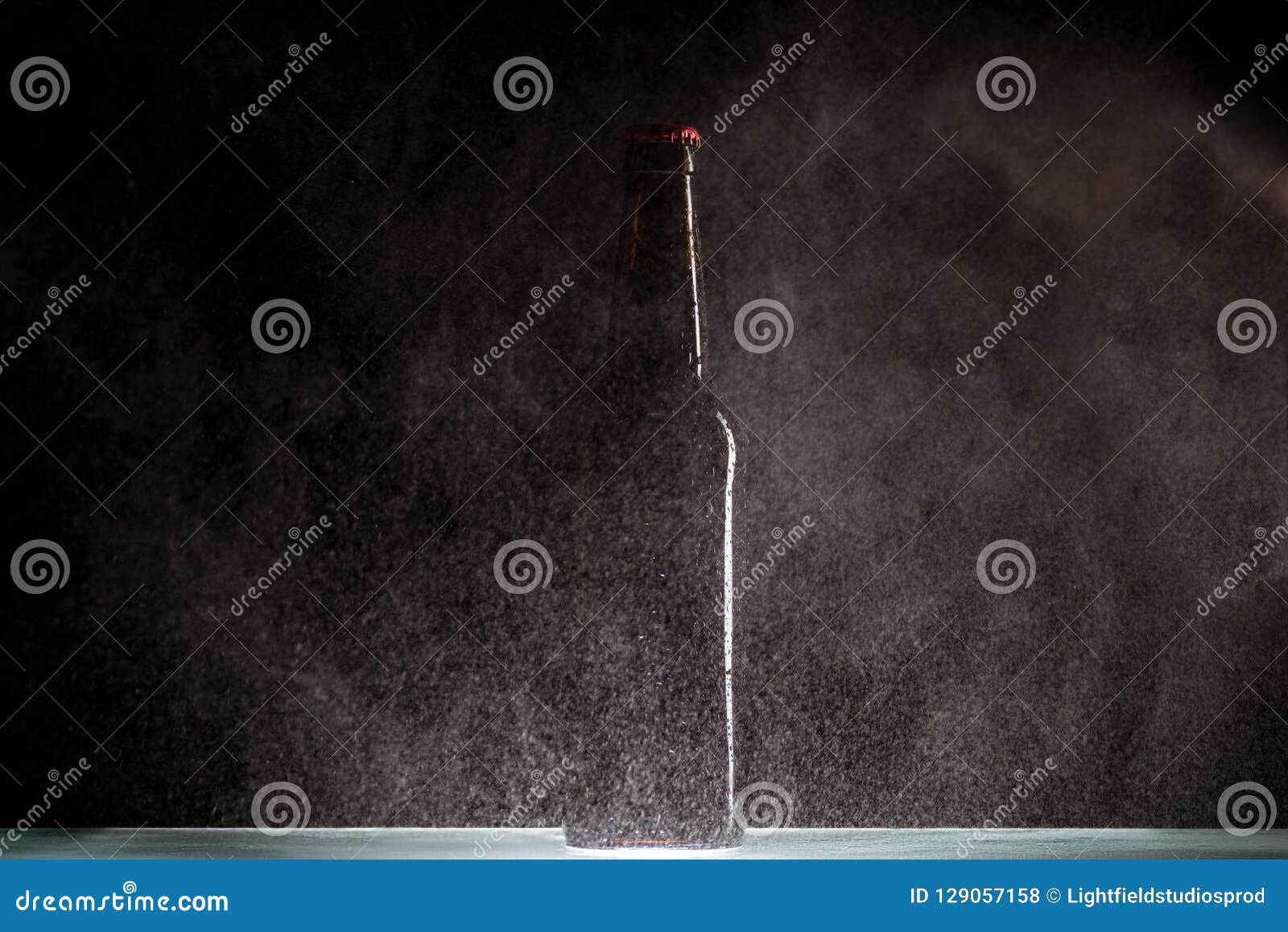 Selective Focus of Beer Bottle with Spraying Water Around at Surface on ...