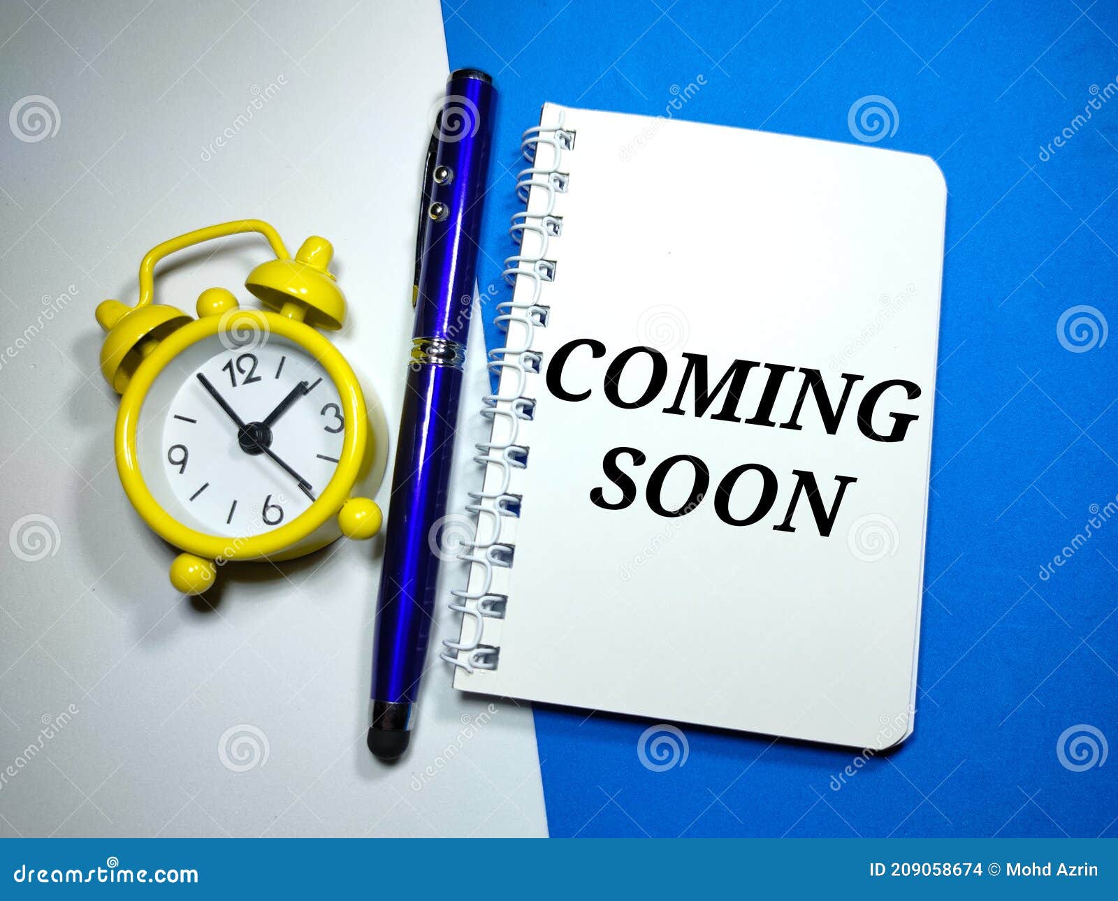 Selective Focus.Clock,pen and Word COMING SOON on a Notebook with Blue ...
