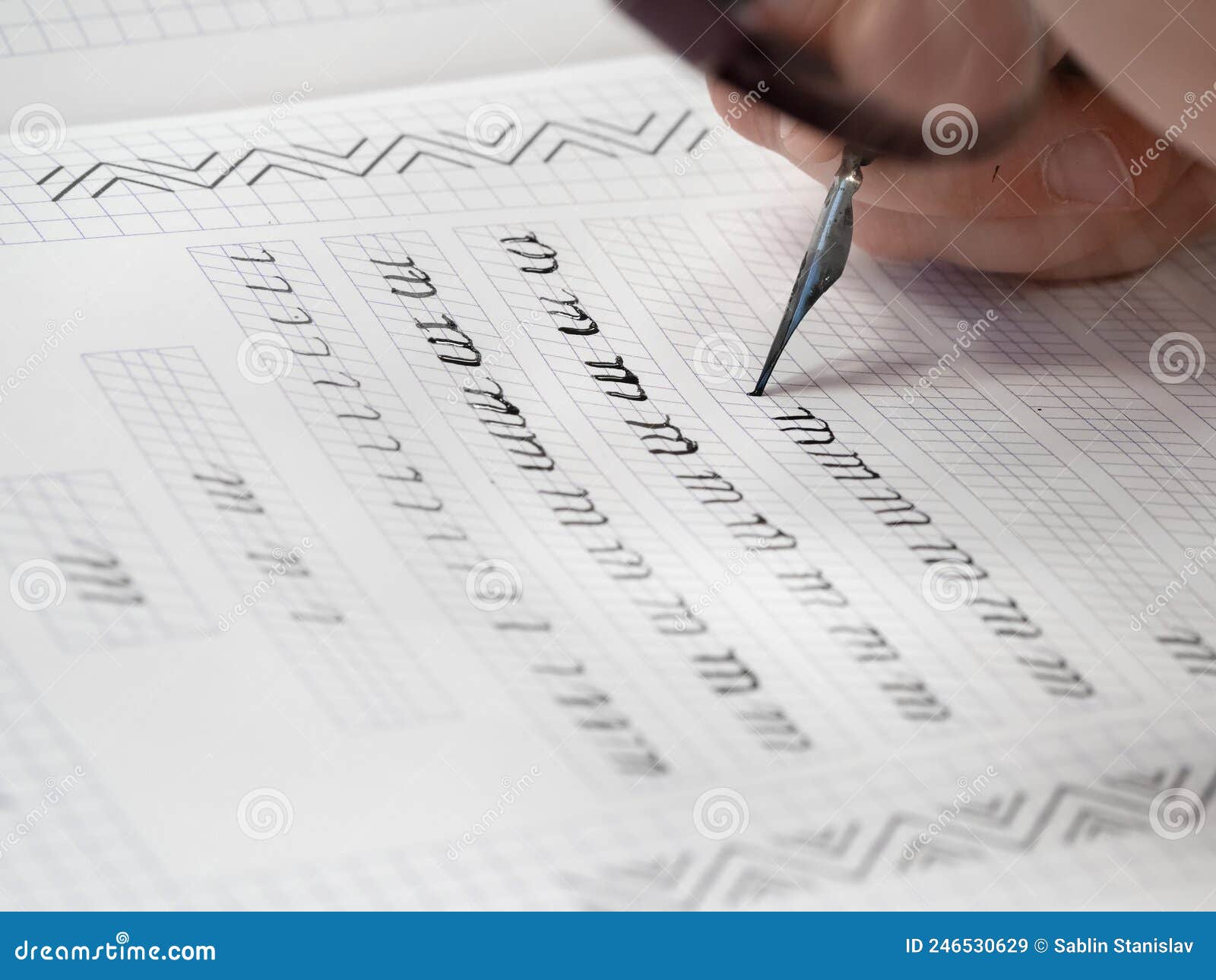 Close-up Pupil`s Hands are Writing Calligraphy in a Notebook. Schoolboy ...
