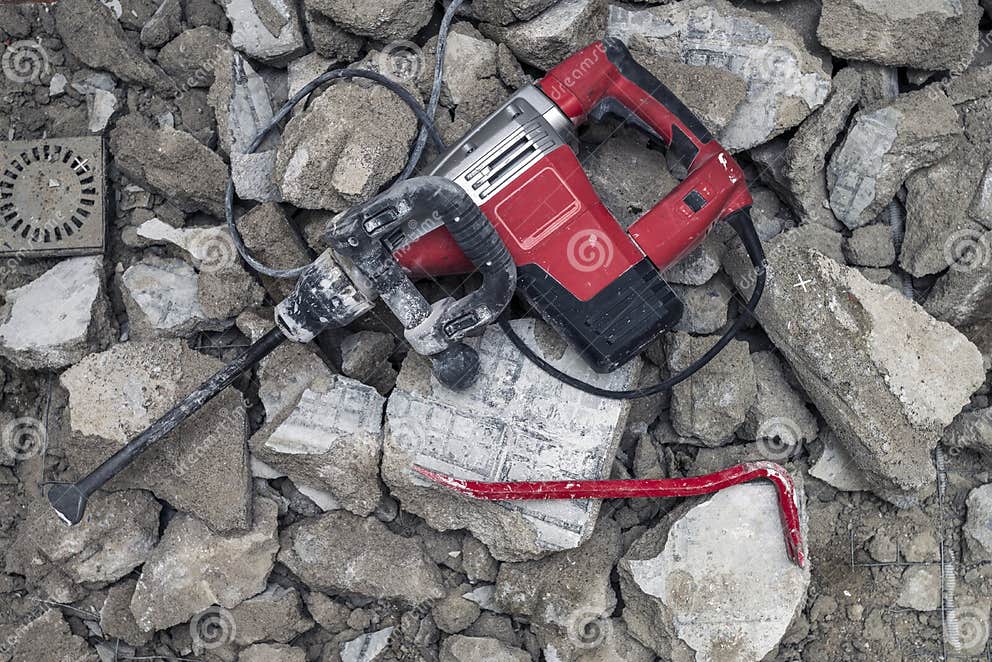The Crowbar and Jackhammer Lies on Large Pieces of Broken Cement Walls ...