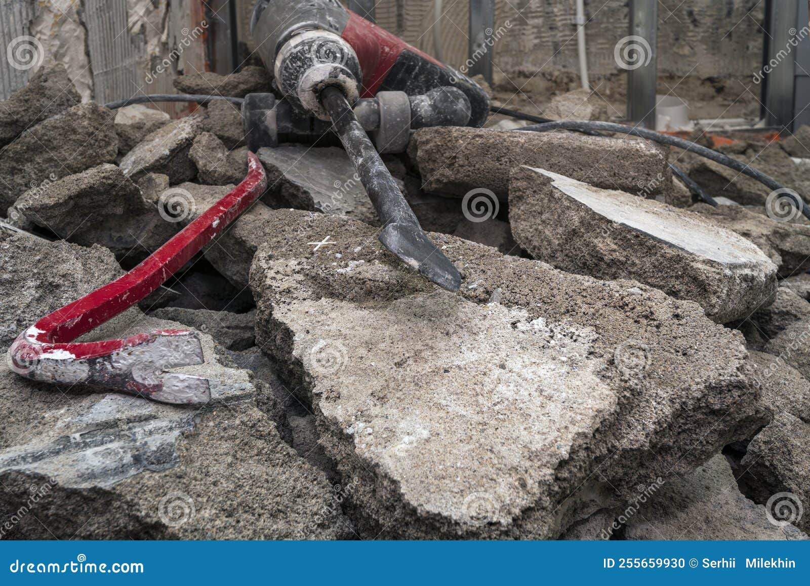 The Crowbar and Jackhammer Lies on Large Pieces of Broken Cement Walls ...