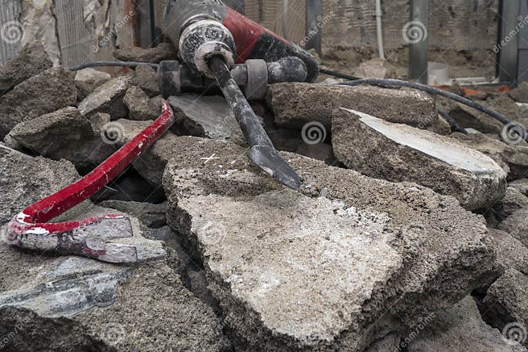 The Crowbar and Jackhammer Lies on Large Pieces of Broken Cement Walls ...