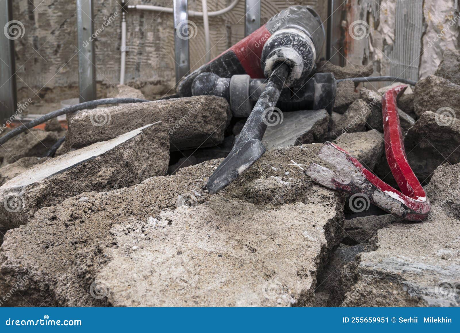 The Crowbar and Jackhammer Lies on Large Pieces of Broken Cement Walls ...