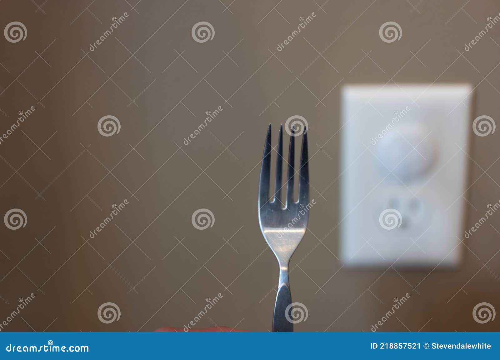 Selective Focus on Edge of a Metal Fork about To Be Inserted into an ...