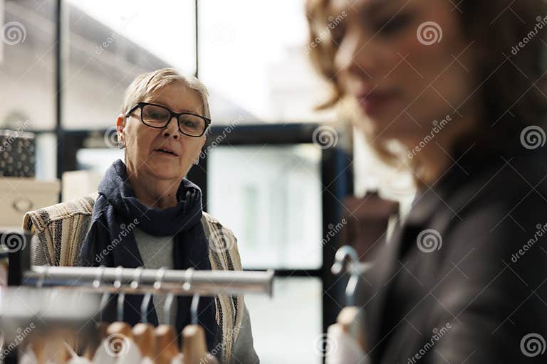 Selective Focus of Elderly Customer Asking Employee for Help Stock ...