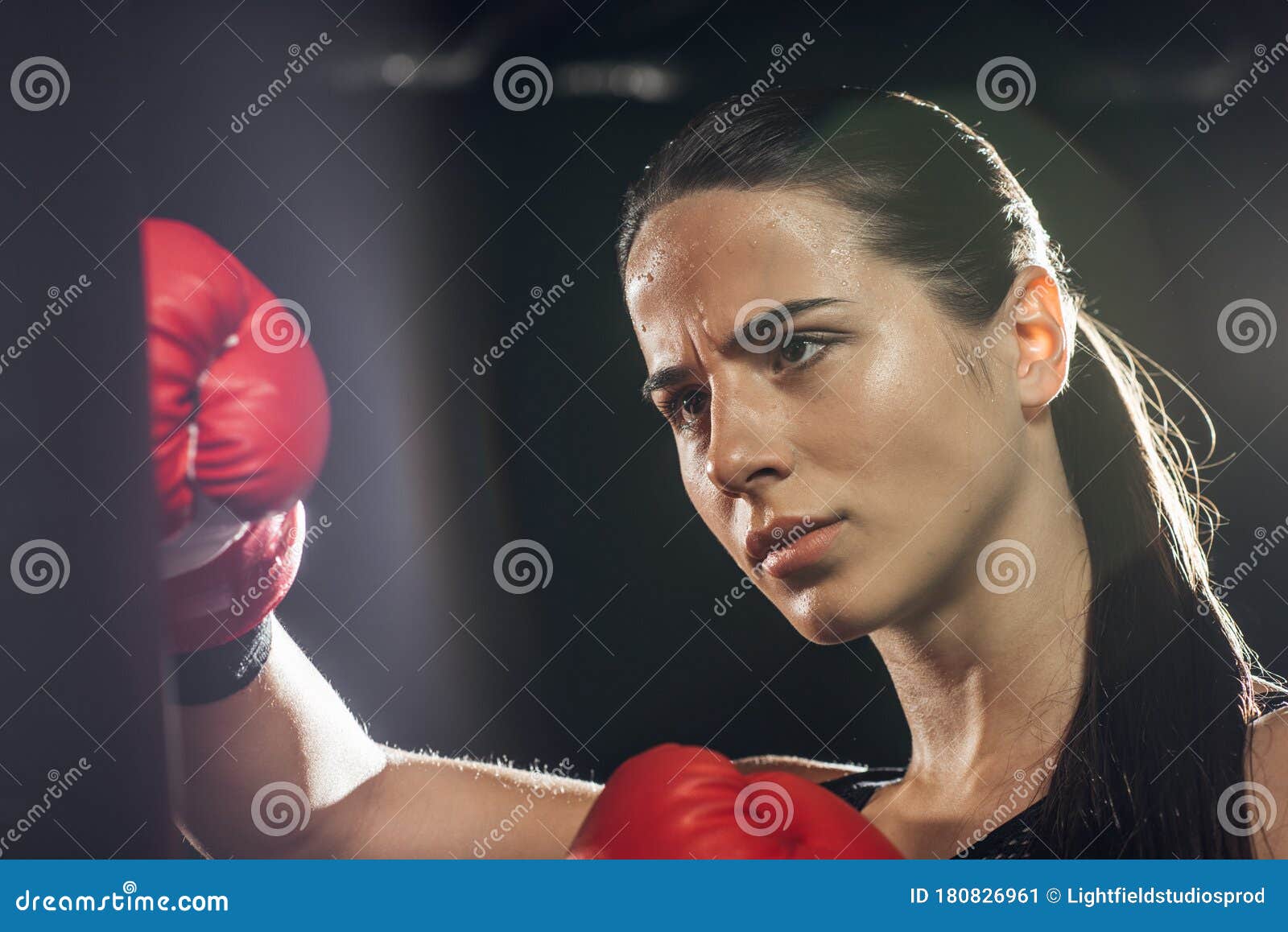 Selective Focus of Exhausted Boxer Training with Punching Bag on Black ...
