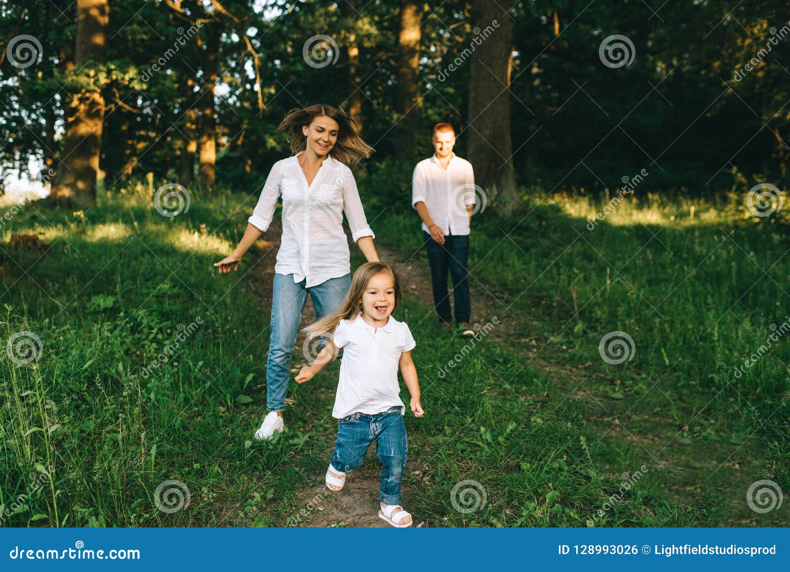Side View of Family Resting on Cloth on Ground Together Stock Photo ...