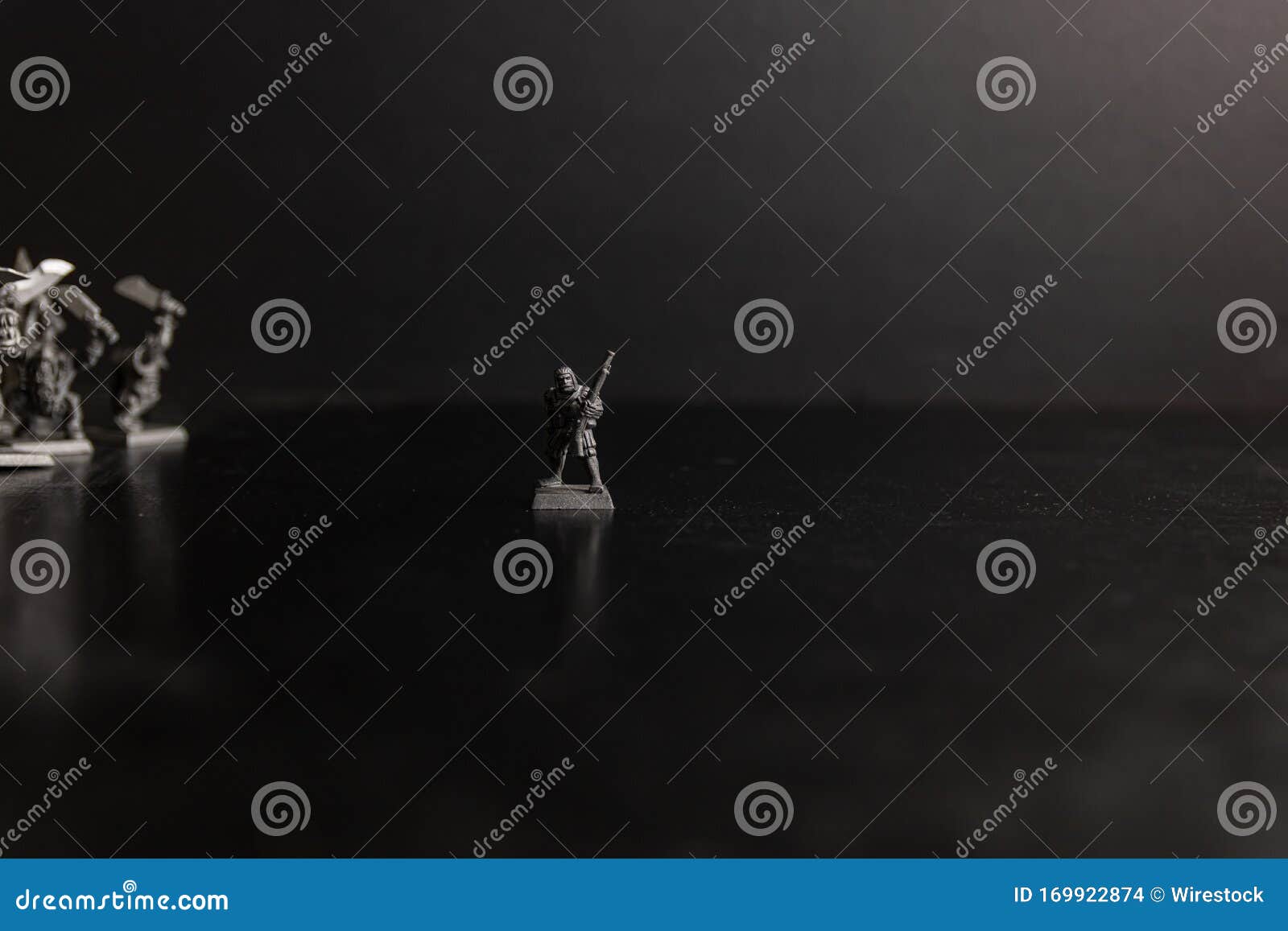 Selective Focus Grayscale Shot of a Soldier Holding a Gun Figurine ...