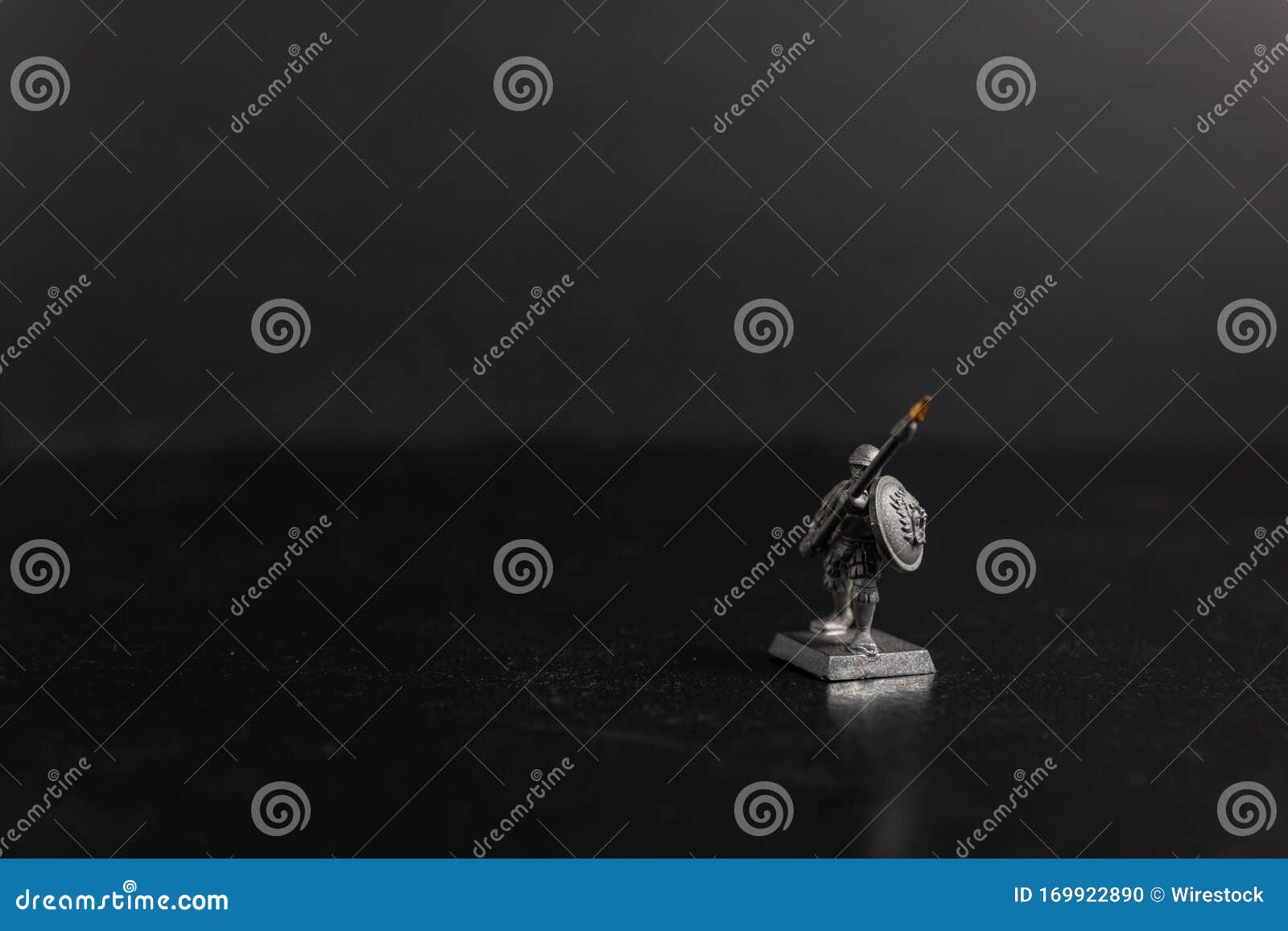 Selective Focus Grayscale Shot of a Spartan Holding a Spear Figurine ...