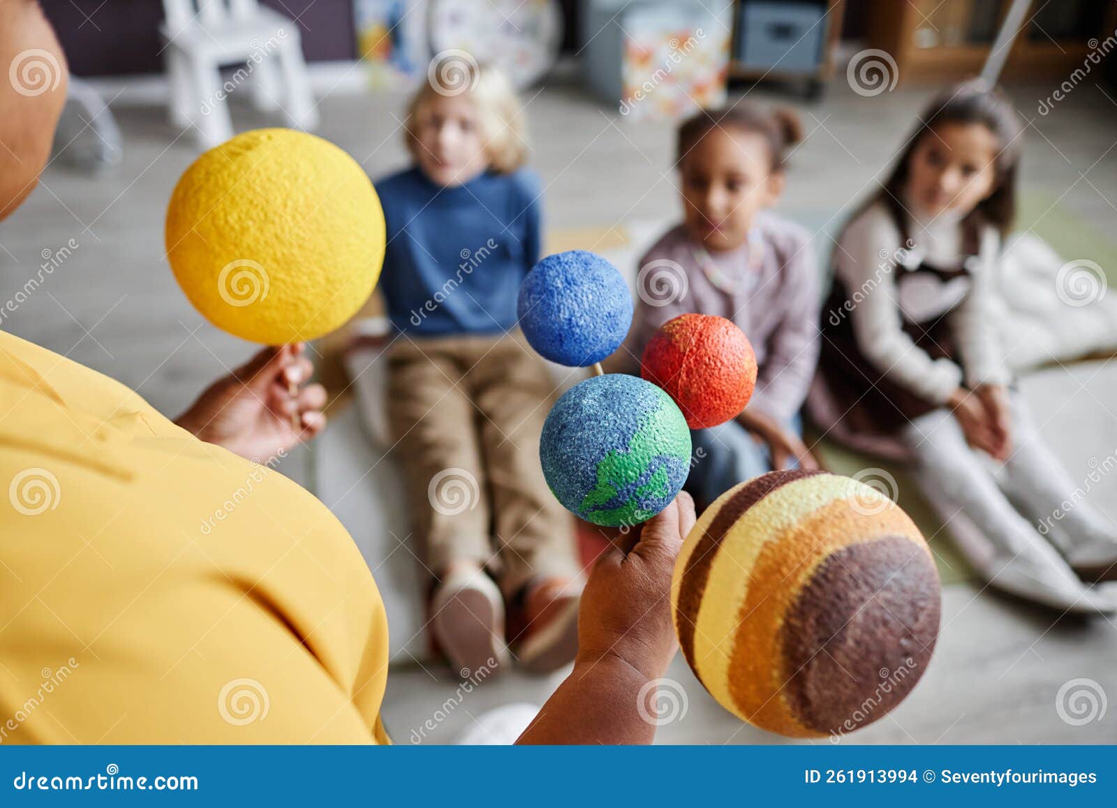 Selective Focus on Group of Planet Models Held by Teacher Stock Photo - Image of nursery ...