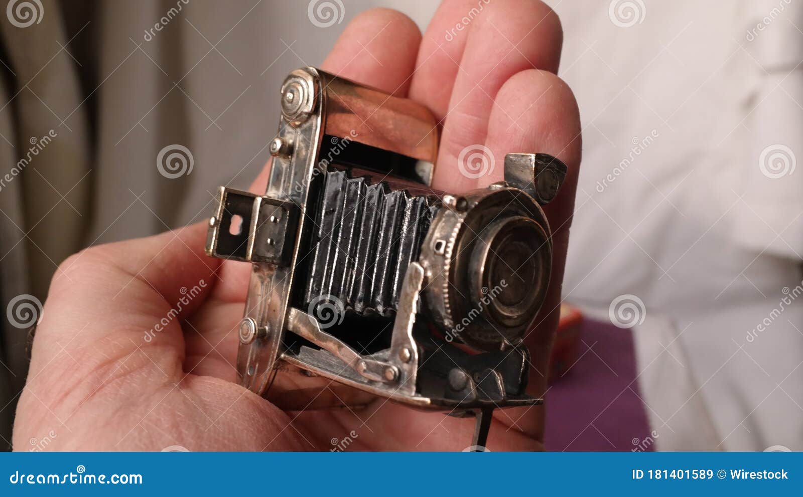 Selective Focus of the Hand of a Person Holding a Small Old Metallic ...