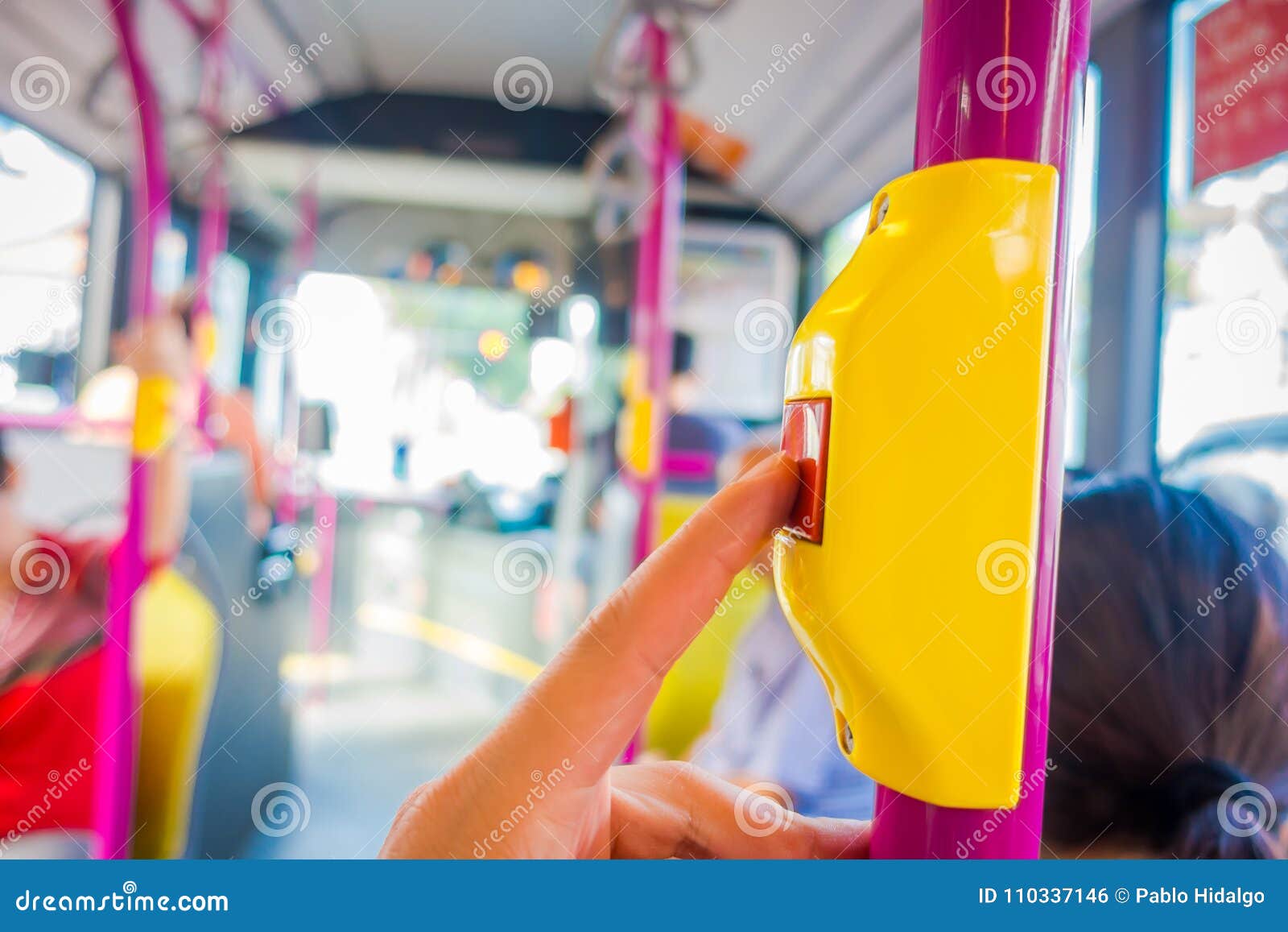 Selective Focus of a Hand Pushing a Bus Stop Button Inside of the Bus ...