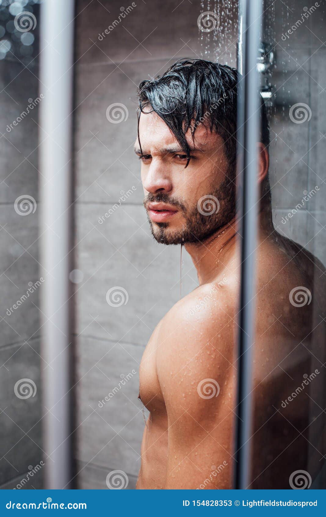 Selective Focus Of Handsome Bearded Man Taking Shower Stock Image