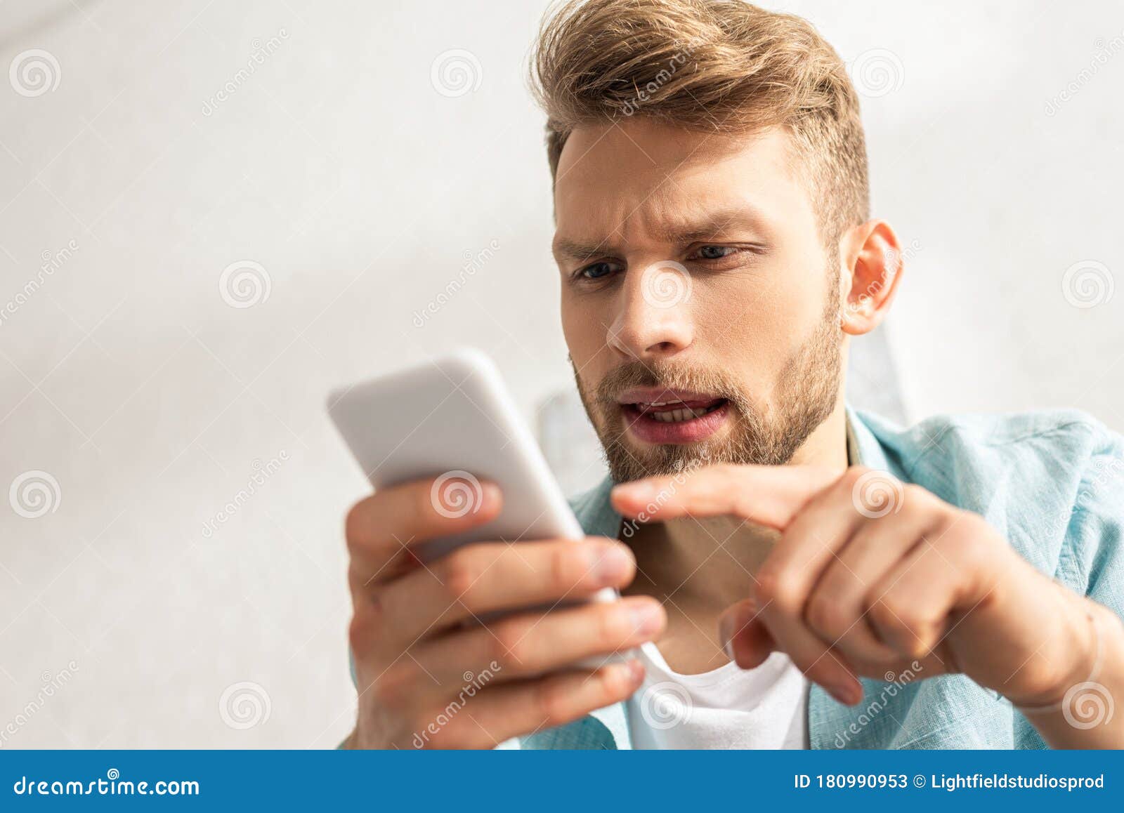 Focus of Handsome Man Pointing with Finger at Smartphone Stock Image ... Focus of Handsome Man Pointing with Finger at Smartphone Stock Image ...