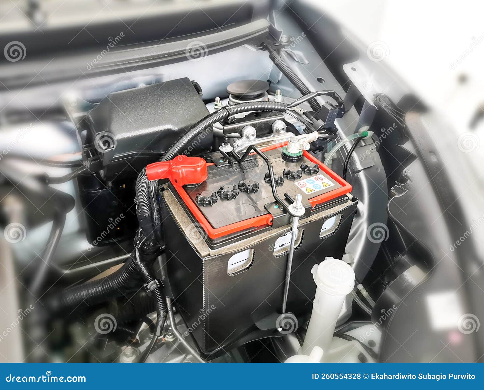 Selective Focus Image of Battery in Car Engine Compartment with Blurry ...
