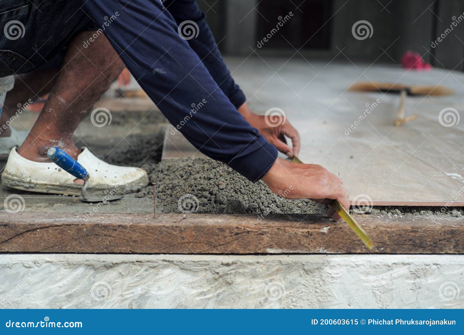 Selective Focus on Leg and Hands of Worker Measuring the Floor during ...