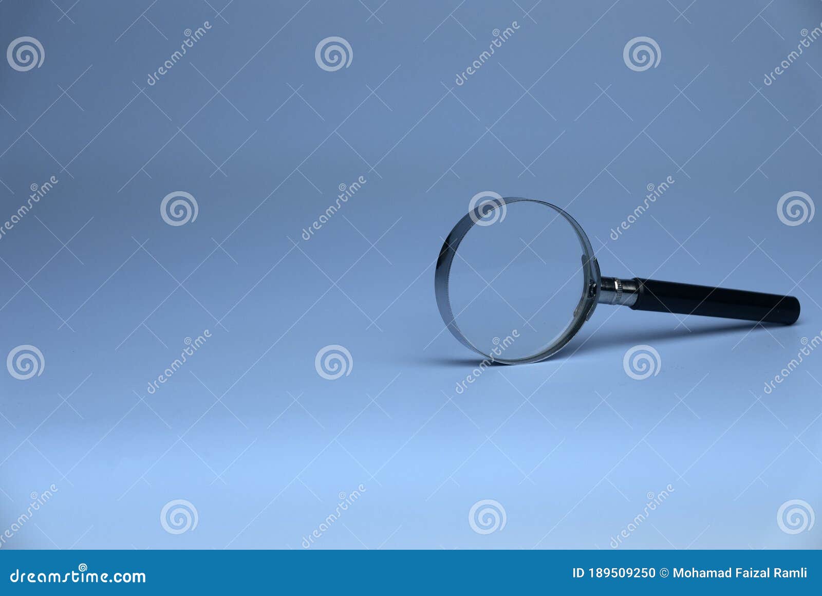 Selective Focus of Magnifying Glass Isolated on a Blue Background with ...