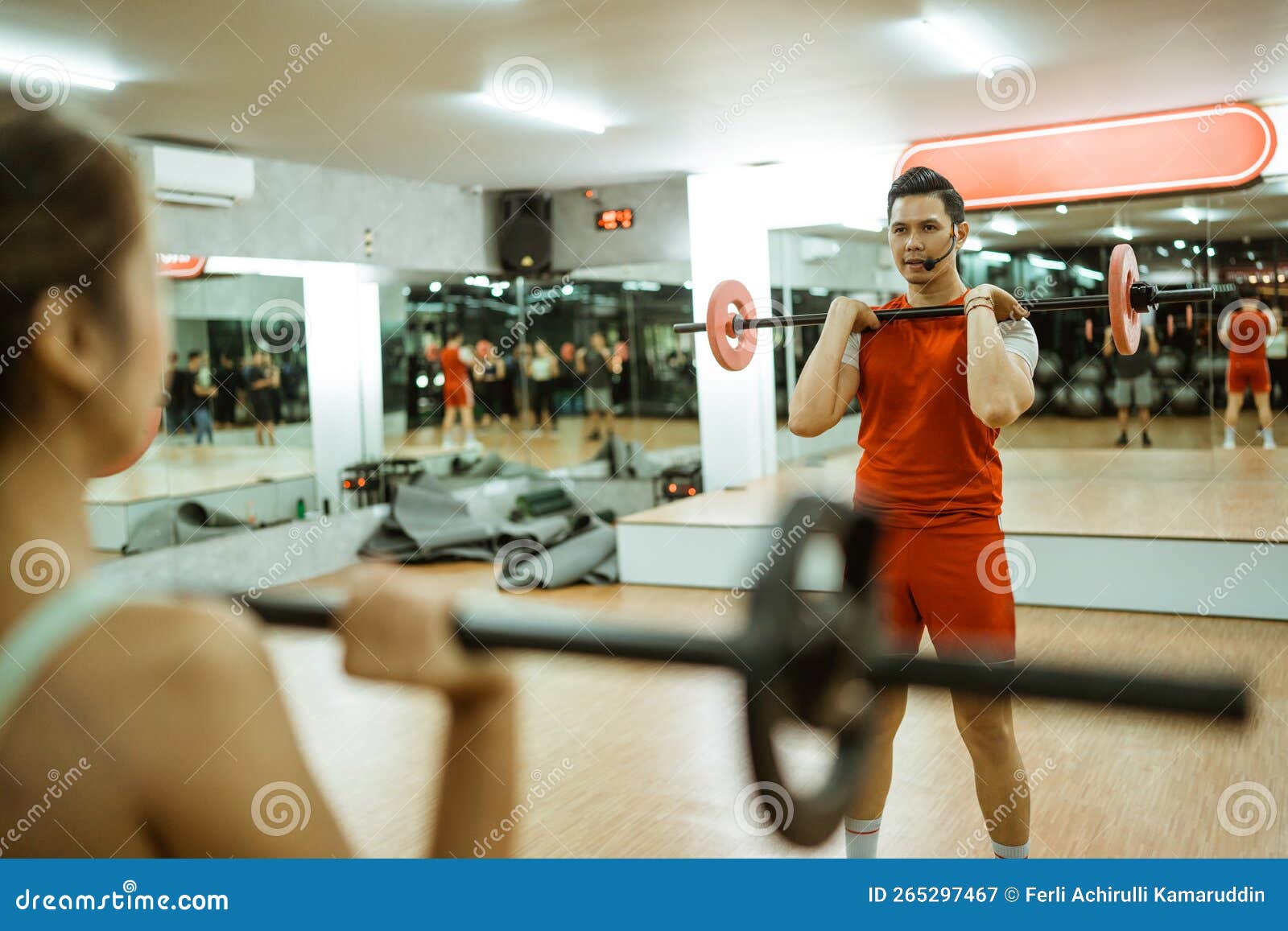 Selective Focus of Male Instructor Lifting Barbell during Group ...