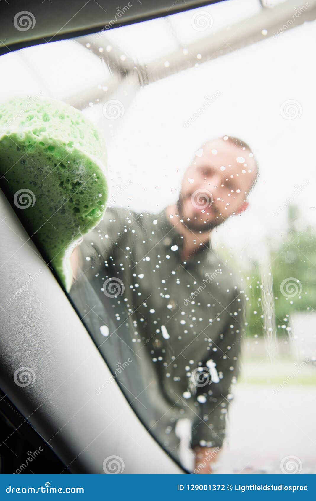 Selective Focus of Man Cleaning Car Front Window with Rag and Soap ...