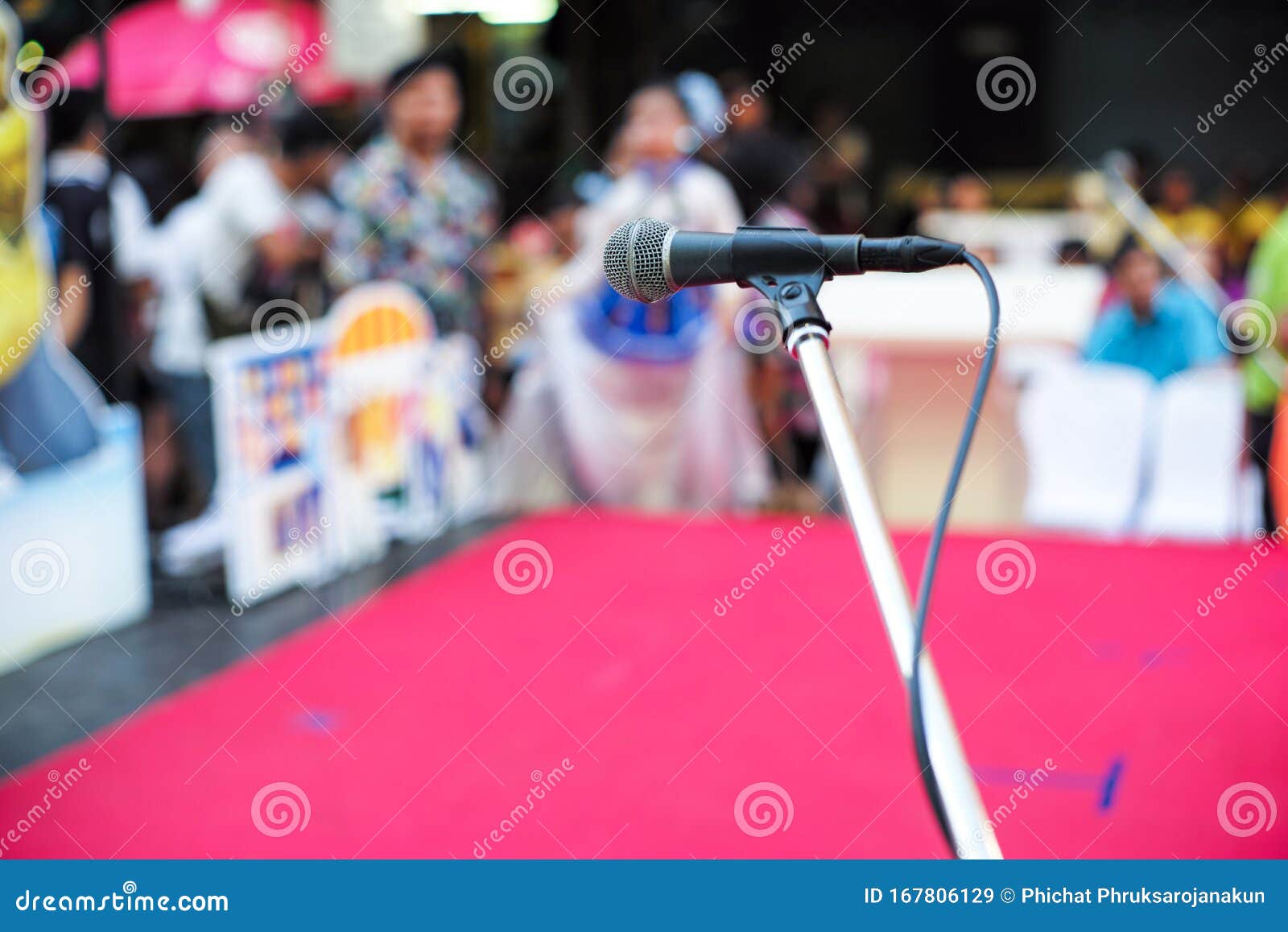 Selective Focus on Microphone on Stage with Blurred Crowd of People in ...