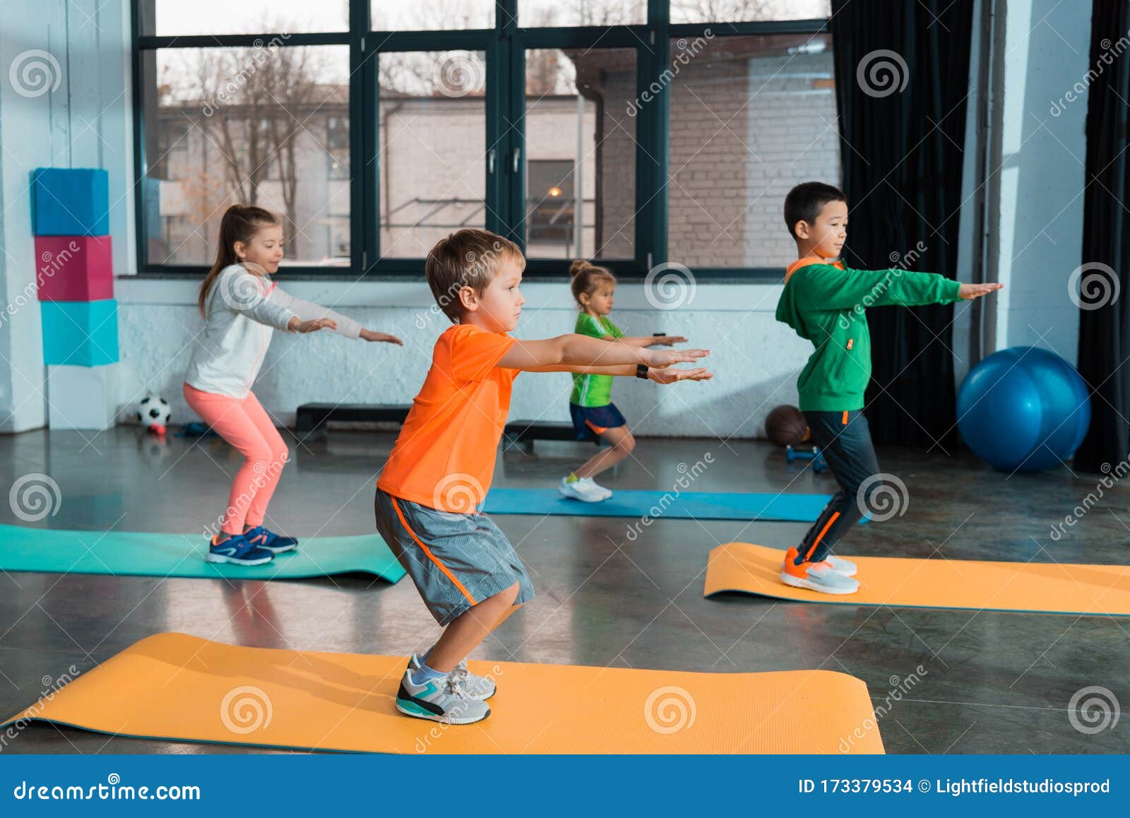 Selective Focus of Multicultural Children Squating Stock Photo - Image ...