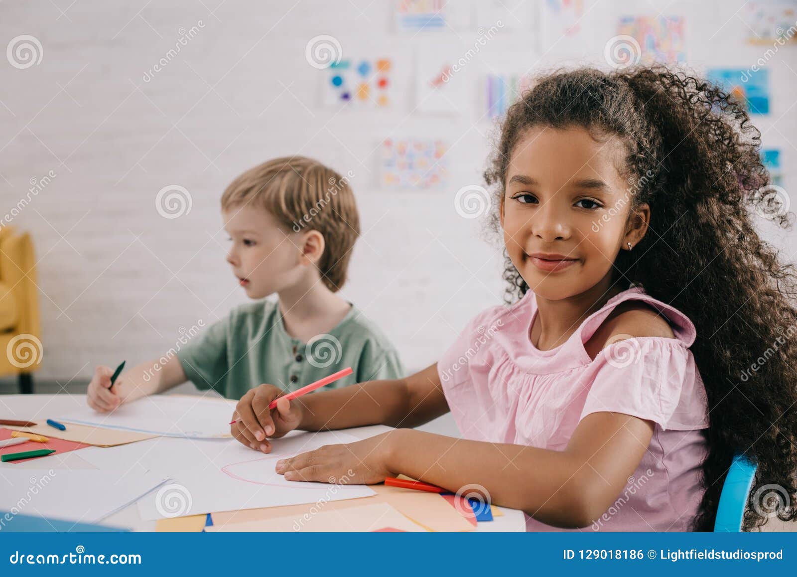 Selective Focus of Multicultural Preschoolers at Table with Papers and ...