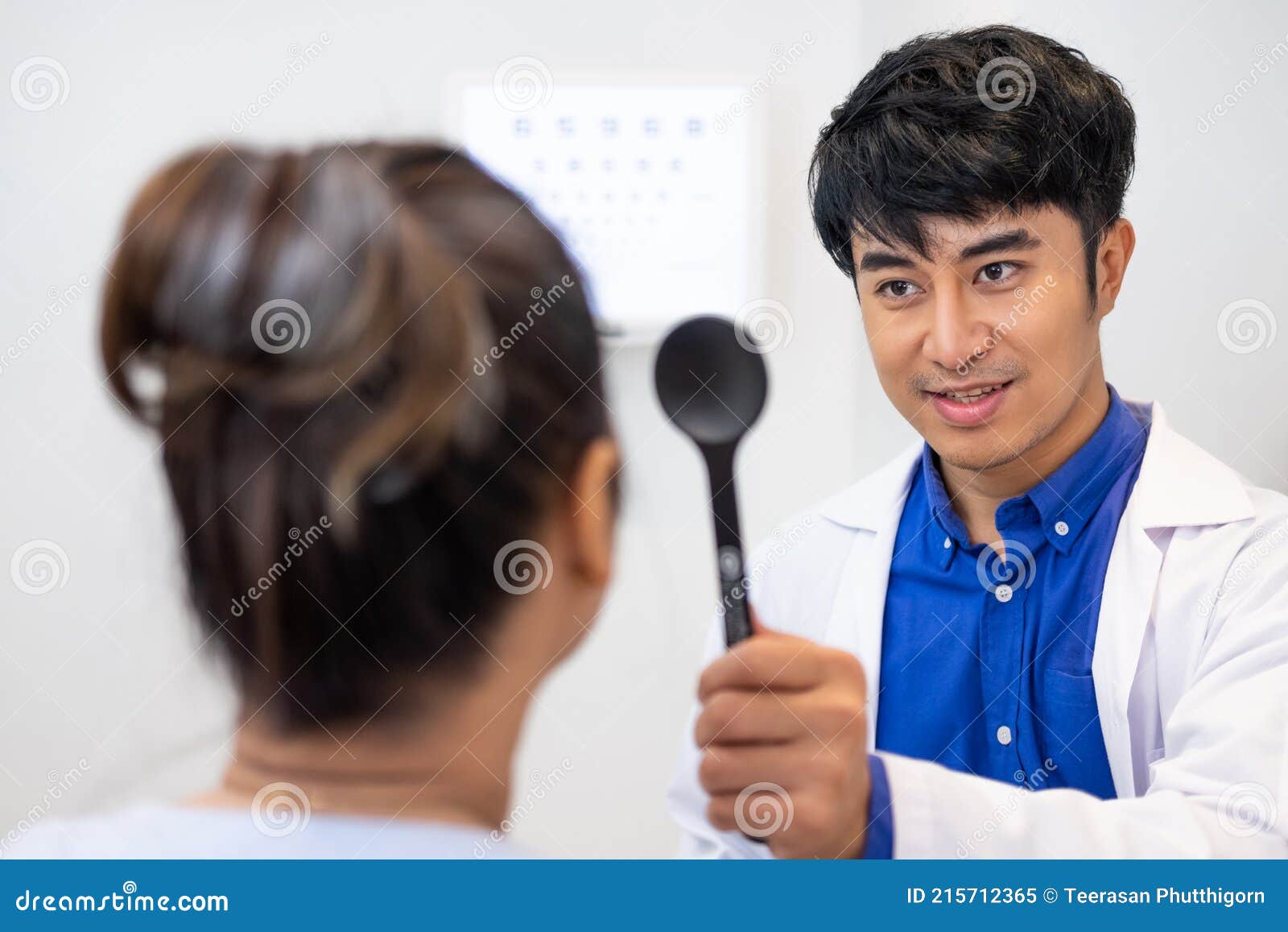 Selective Focus at Optometrist Face. while Doctor Using Penlight and ...