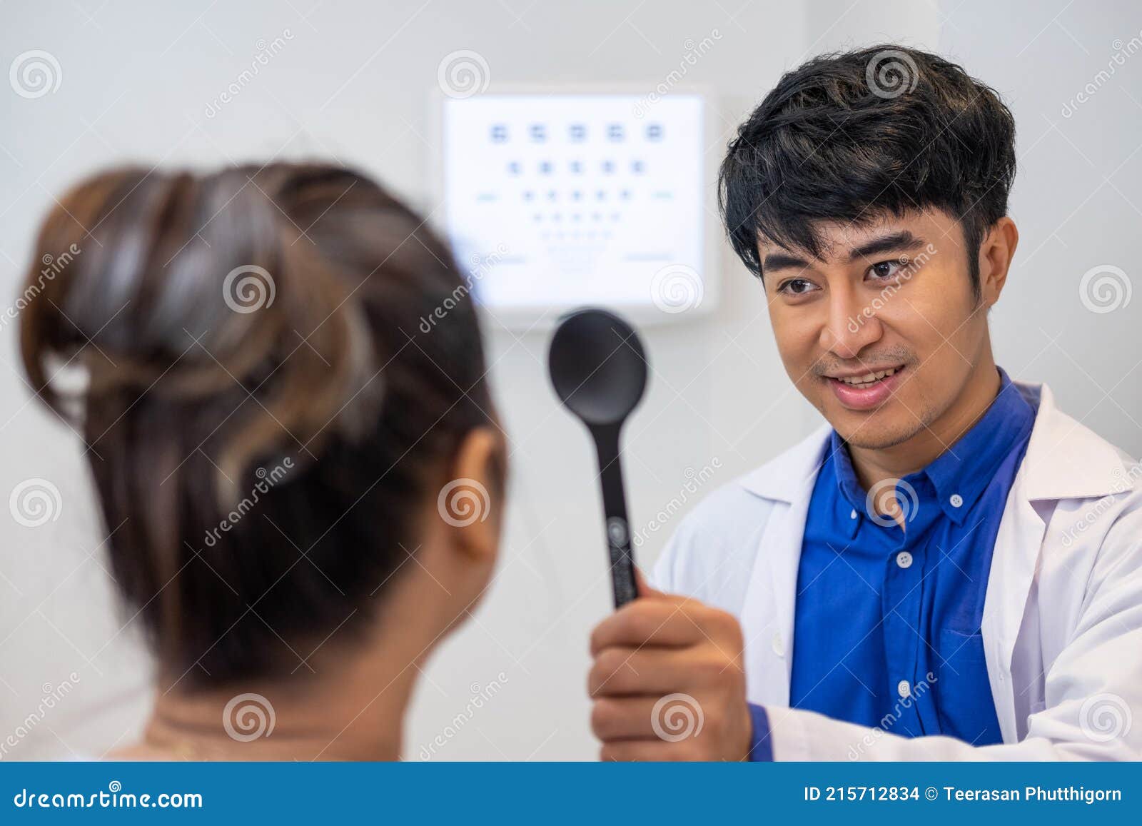 Selective Focus at Optometrist Face. while Doctor Using Penlight and ...