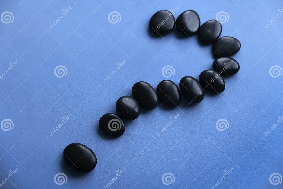 Selective Focus of Question Mark Symbol by Black Stone on Blue ...