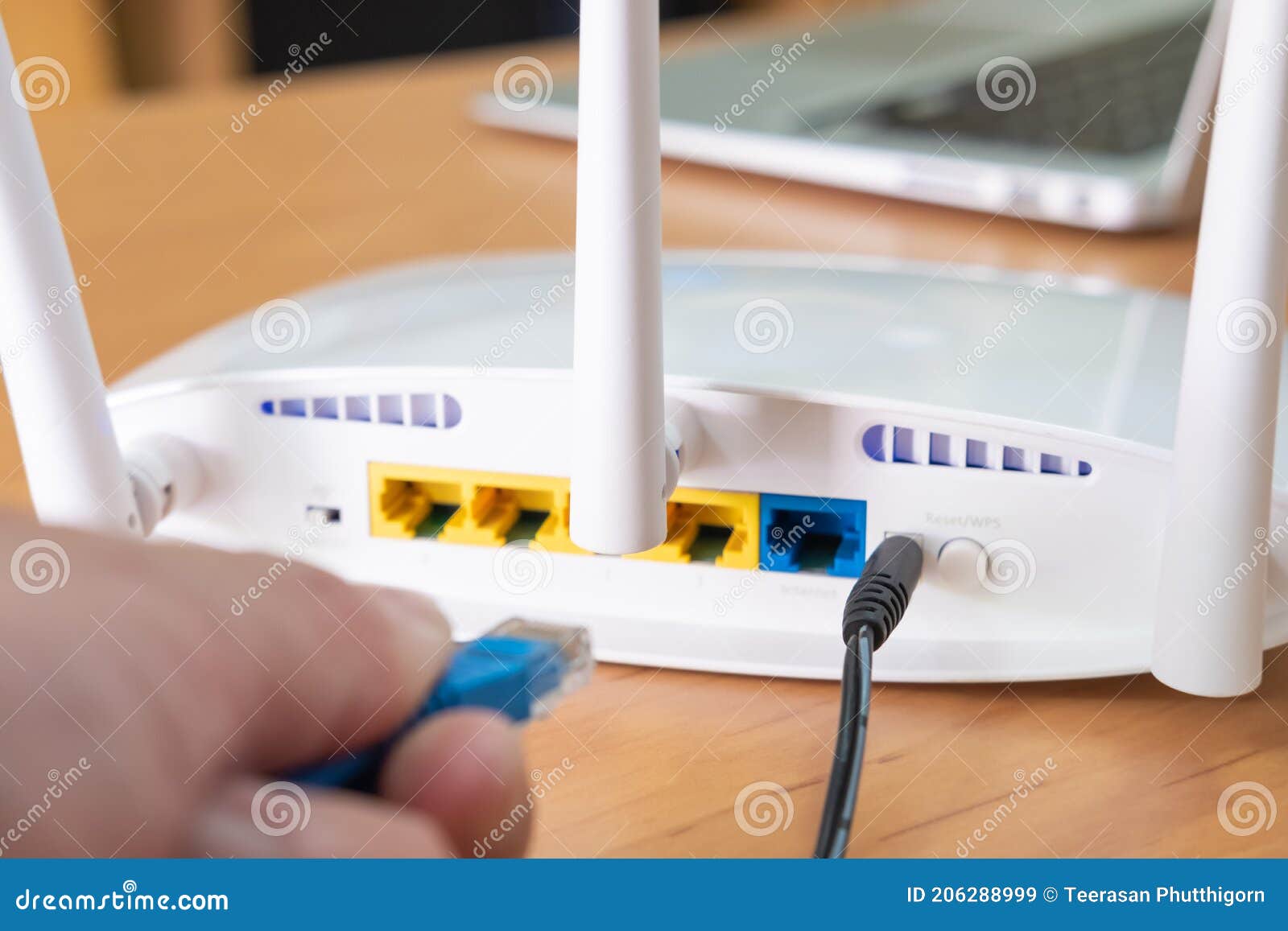 Selective Focus at Router Antenna while Men Hand Connecting Fiber Cable ...