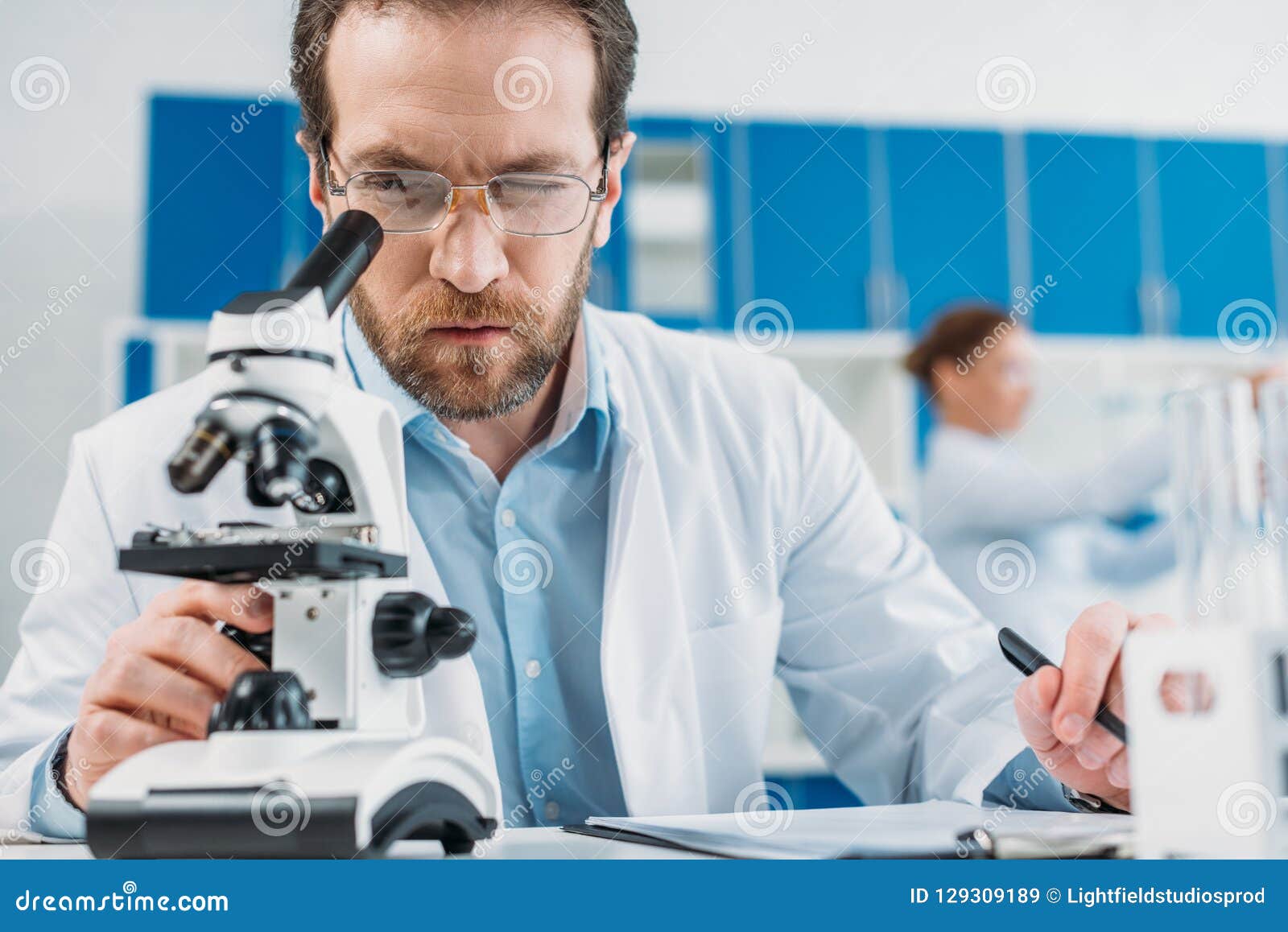 Selective Focus of Scientist in White Coat and Eyeglasses Looking ...
