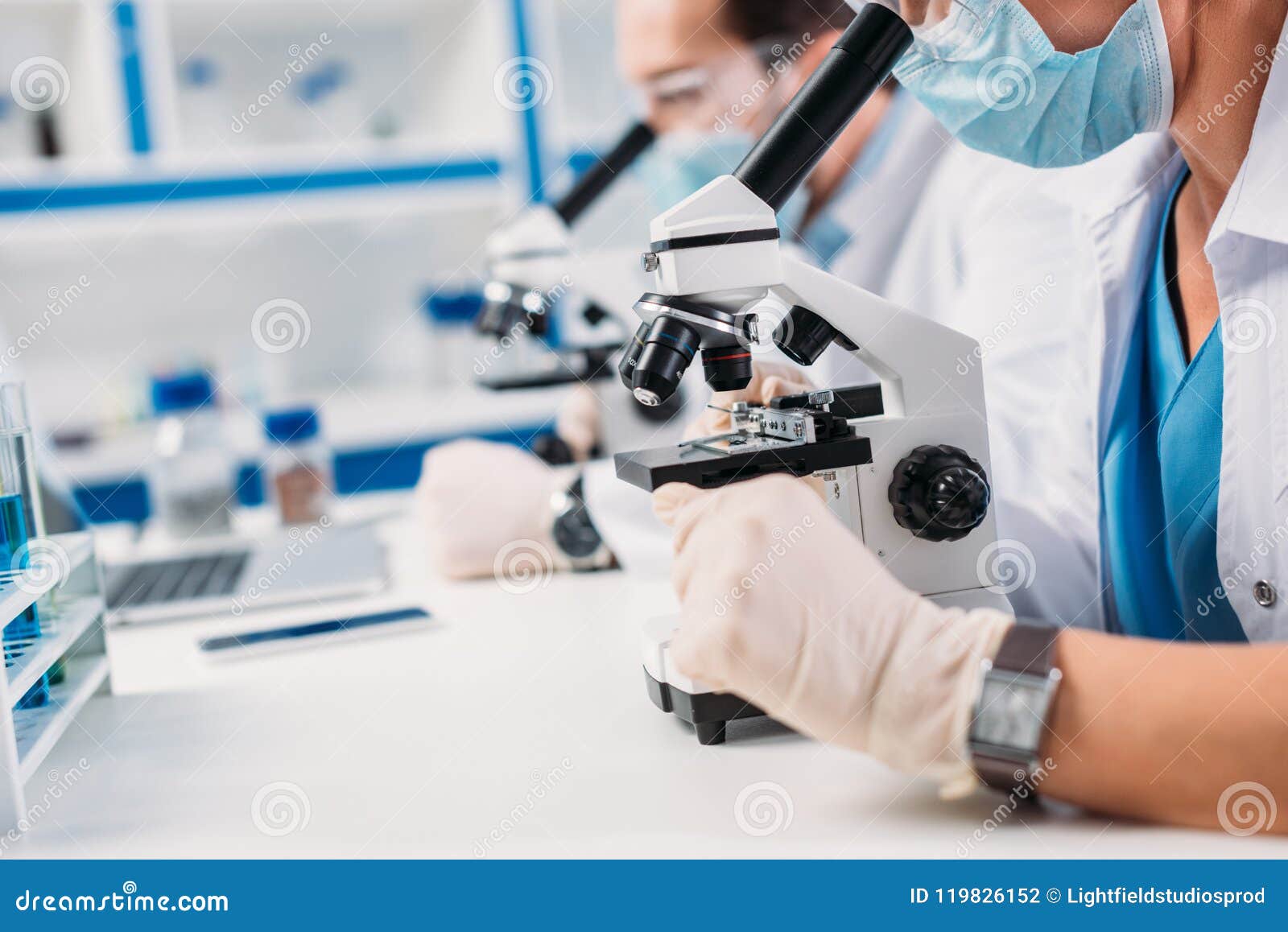 Selective Focus of Scientists in Medical Masks and Goggles Looking ...
