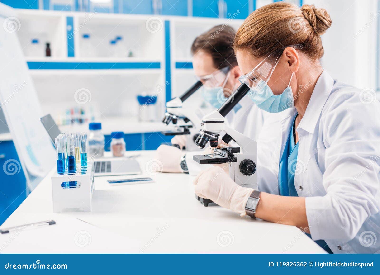 Selective Focus of Scientists in Medical Masks and Goggles Looking ...