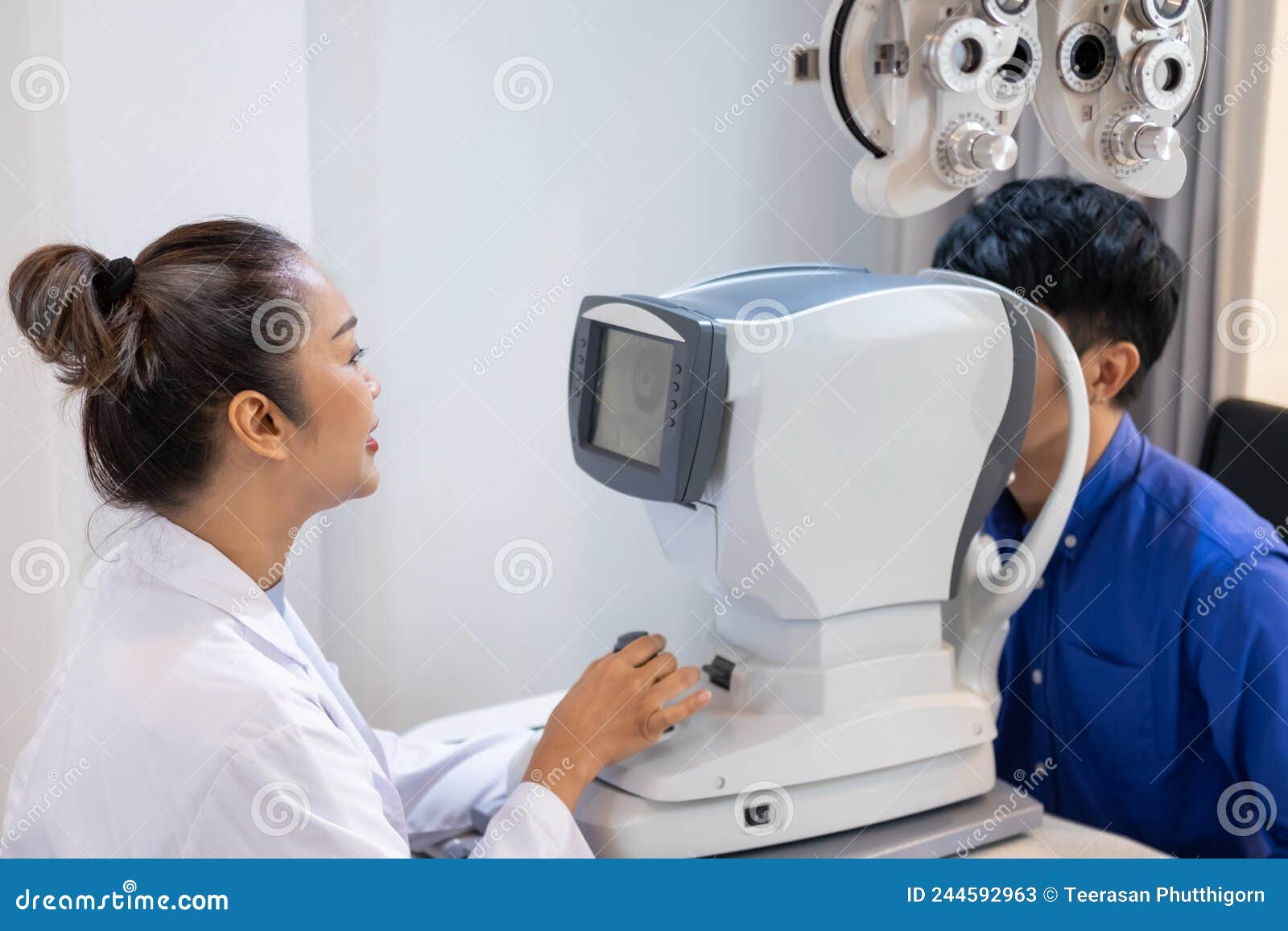 Selective Focus at Screen of Optometry Equipment. while Optometrist ...