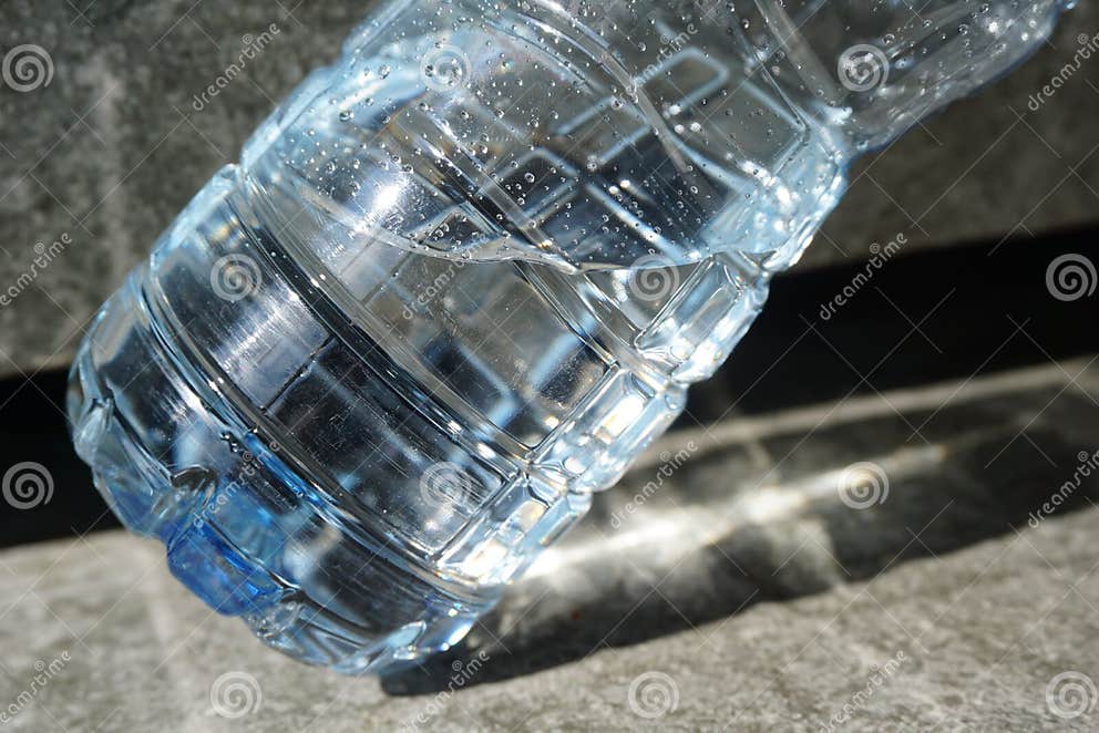 Selective Focus Shot of a Half-empty Water Bottle on a Surface Captured ...